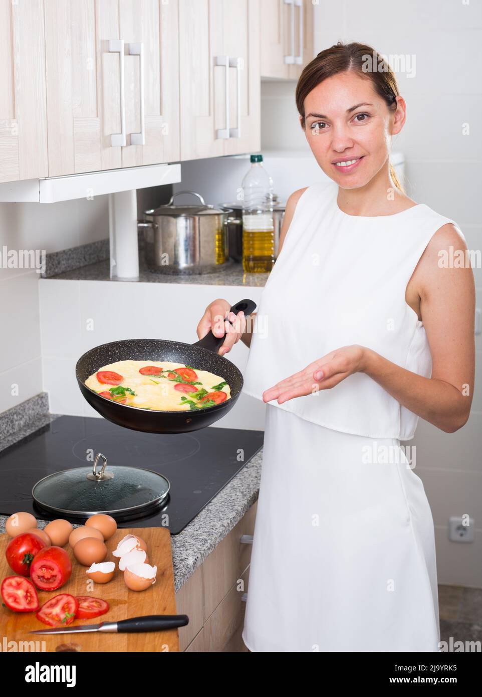 Woman frying vegetables in pan hi-res stock photography and images - Alamy