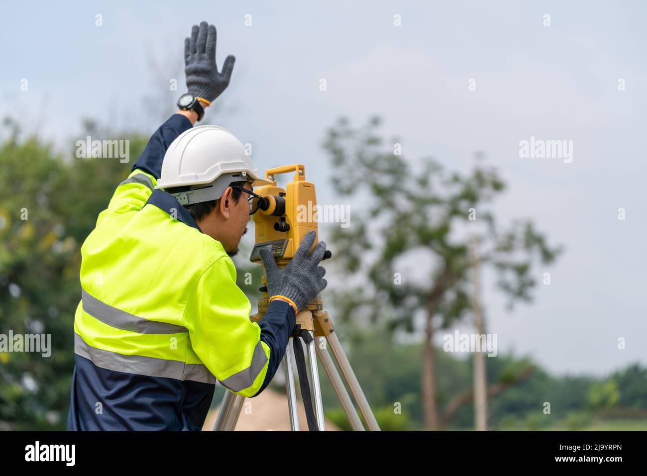Asian Surveyor Civil Engineer working theodolite or total positioning ...