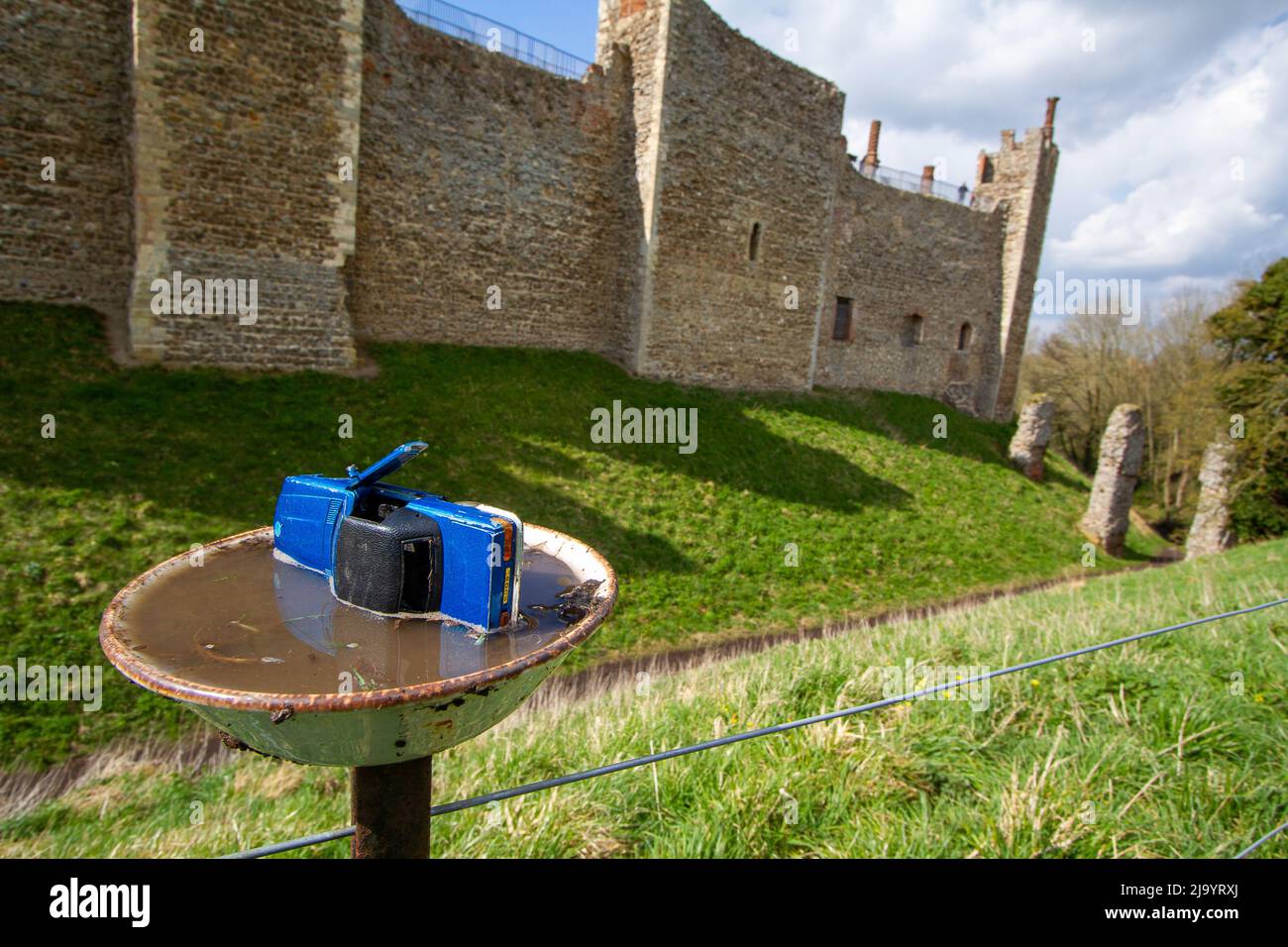 A blue toy car in the foreground, behind the 13th century Framlingham ...