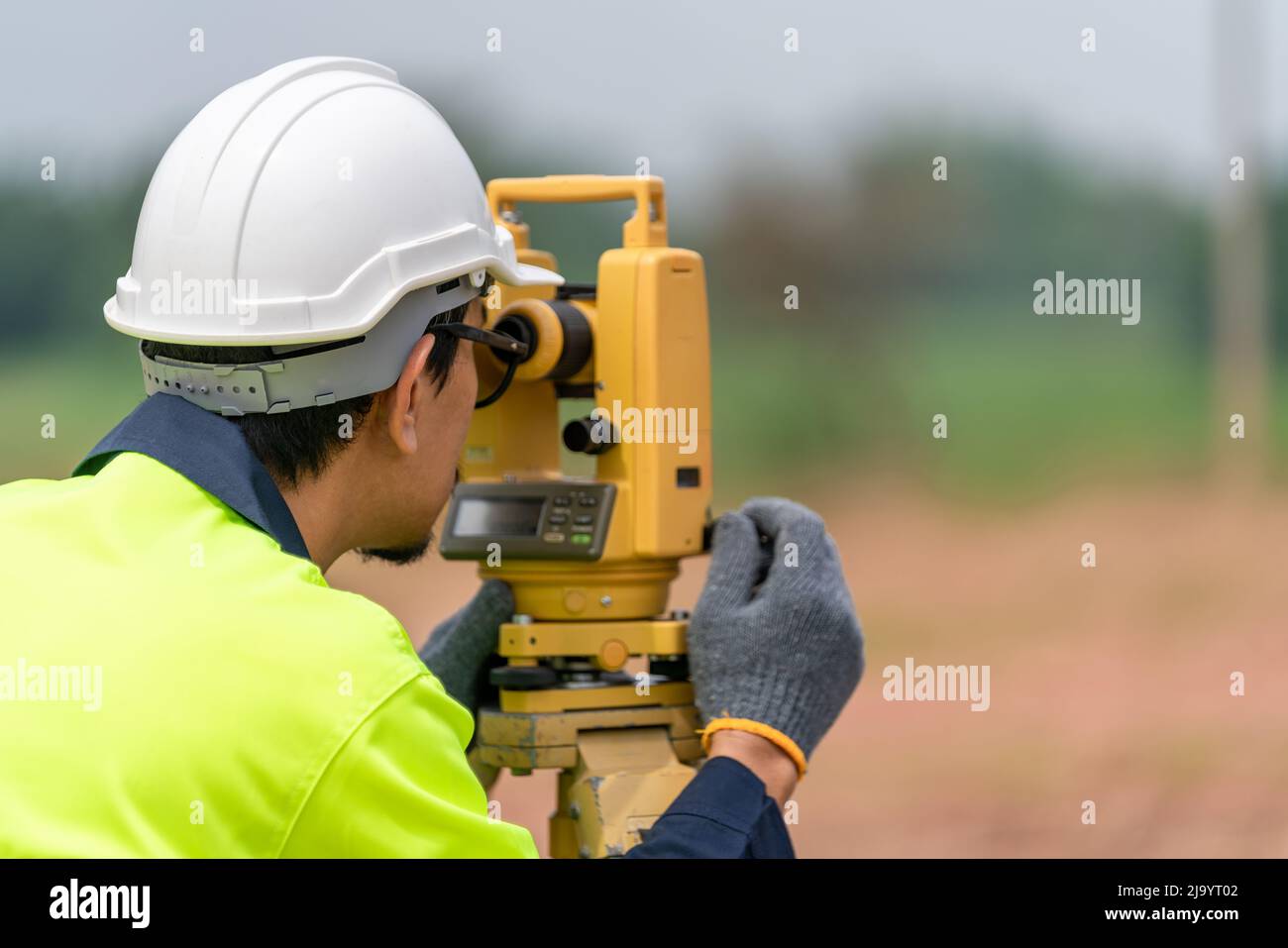 Surveyor Civil Engineer working theodolite or total positioning station ...