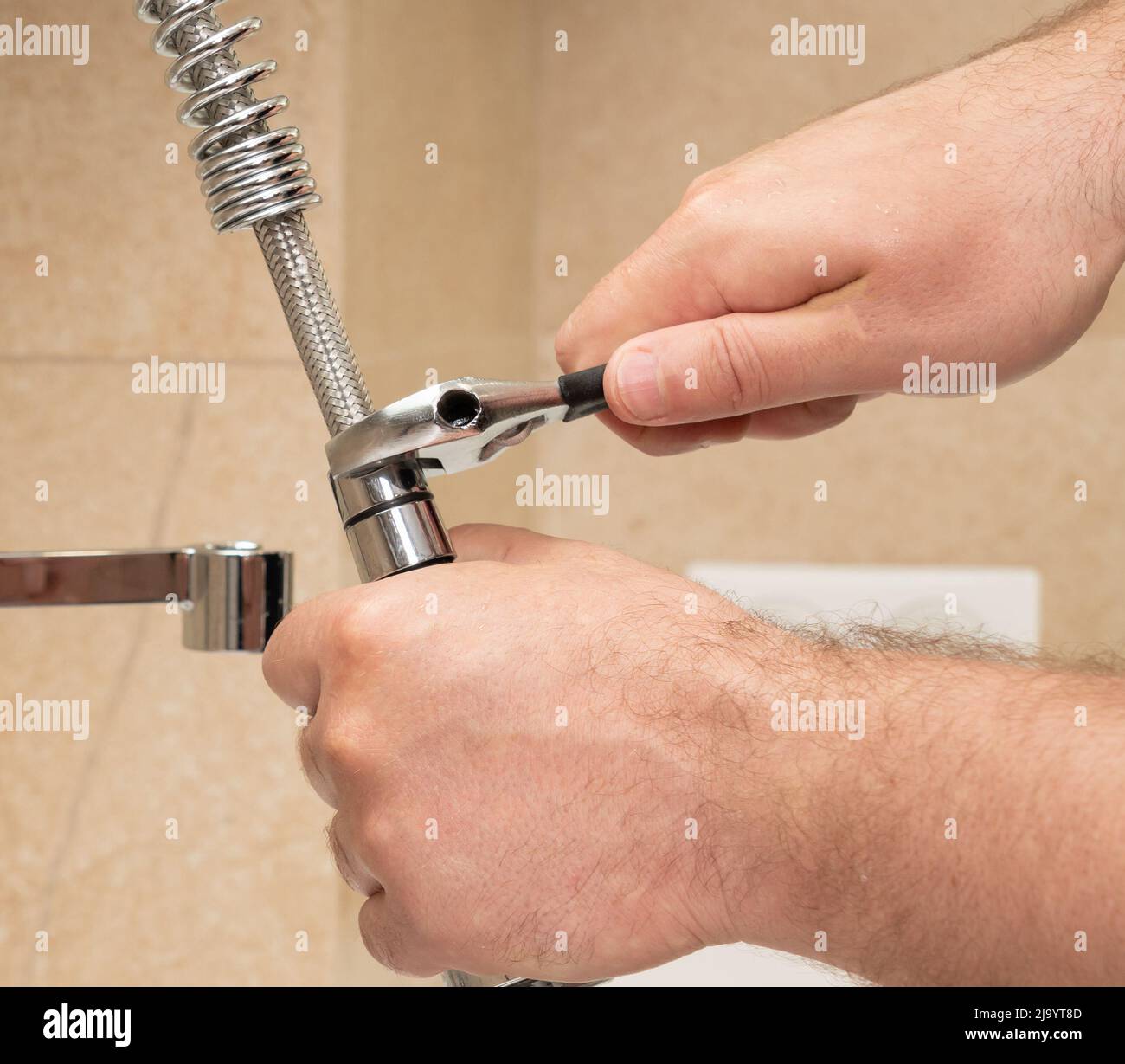 Repair with an adjustable wrench of a modern faucet in the kitchen in ...