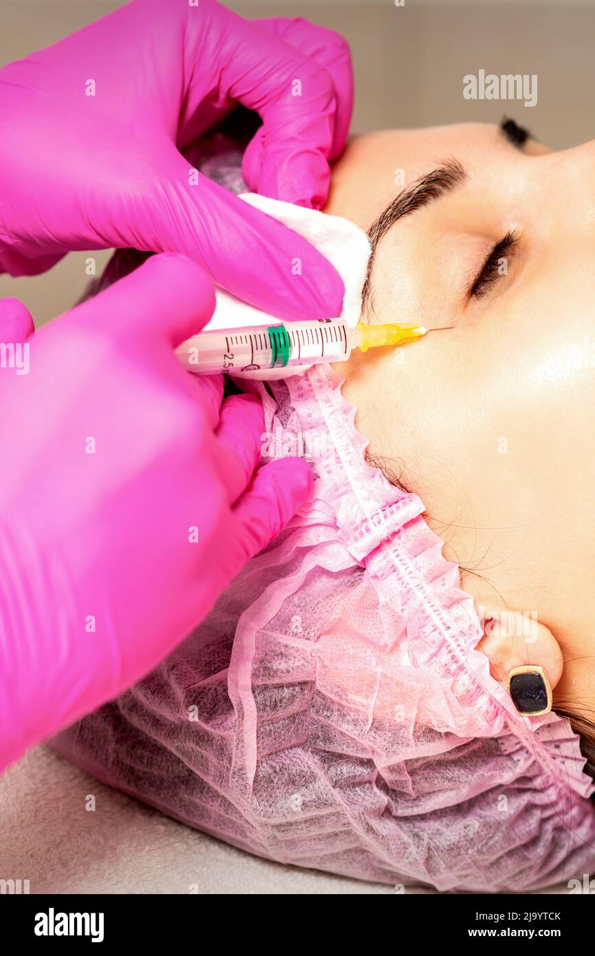 Plastic surgeon injecting rejuvenating hi-res stock photography and ...