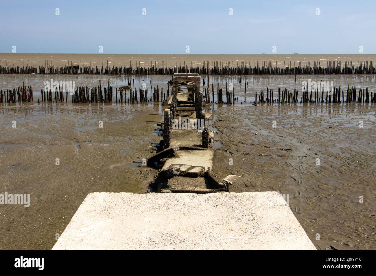 A demolished concrete trail on a pillars at the end of the way with ...