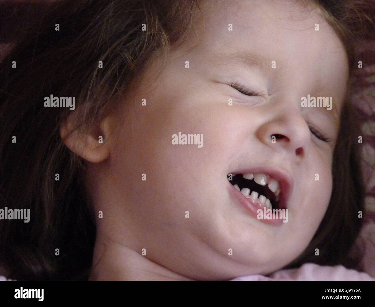 a blue-eyed girl makes strange facial movements Stock Photo - Alamy