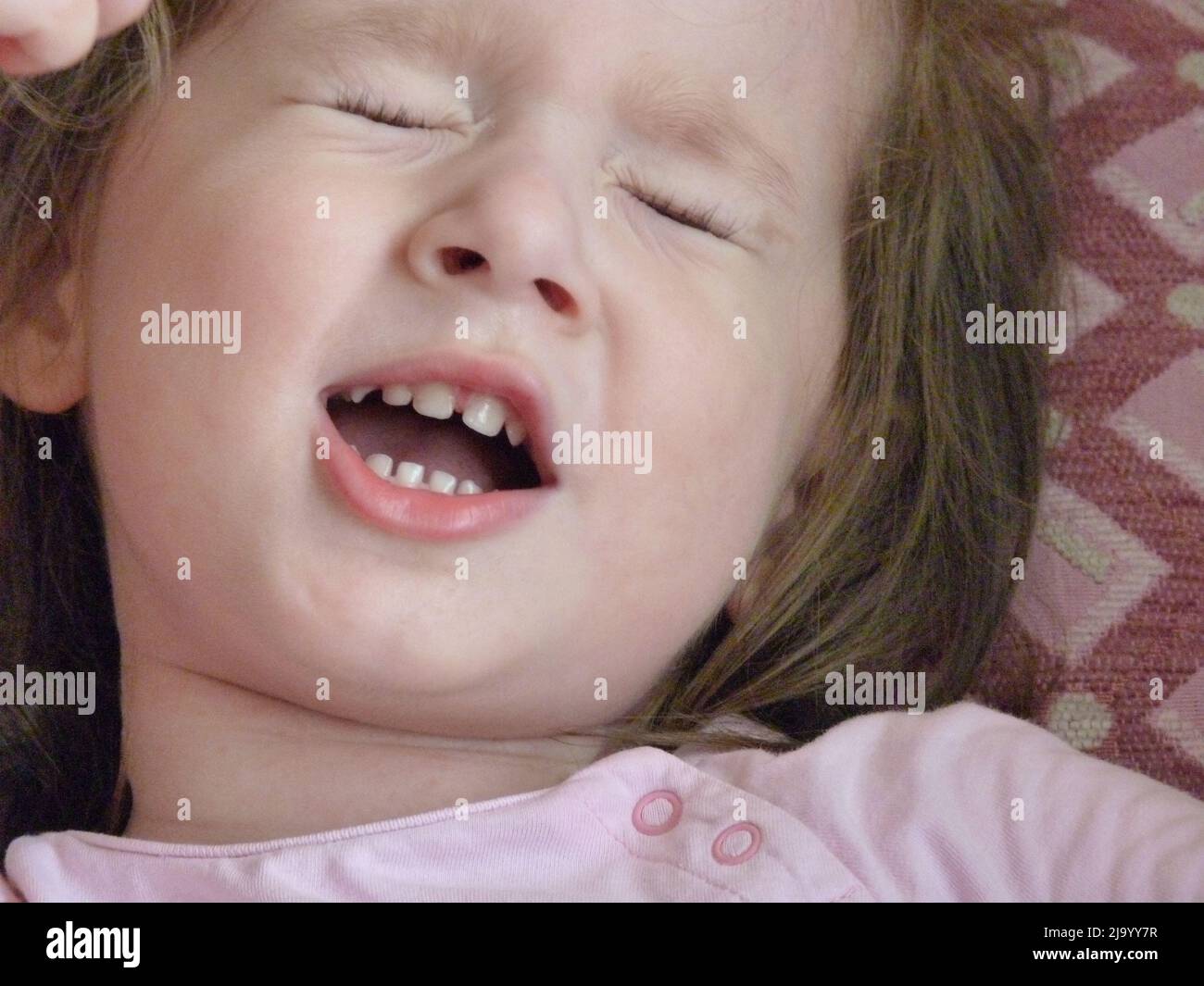 a blue-eyed girl makes strange facial movements Stock Photo - Alamy