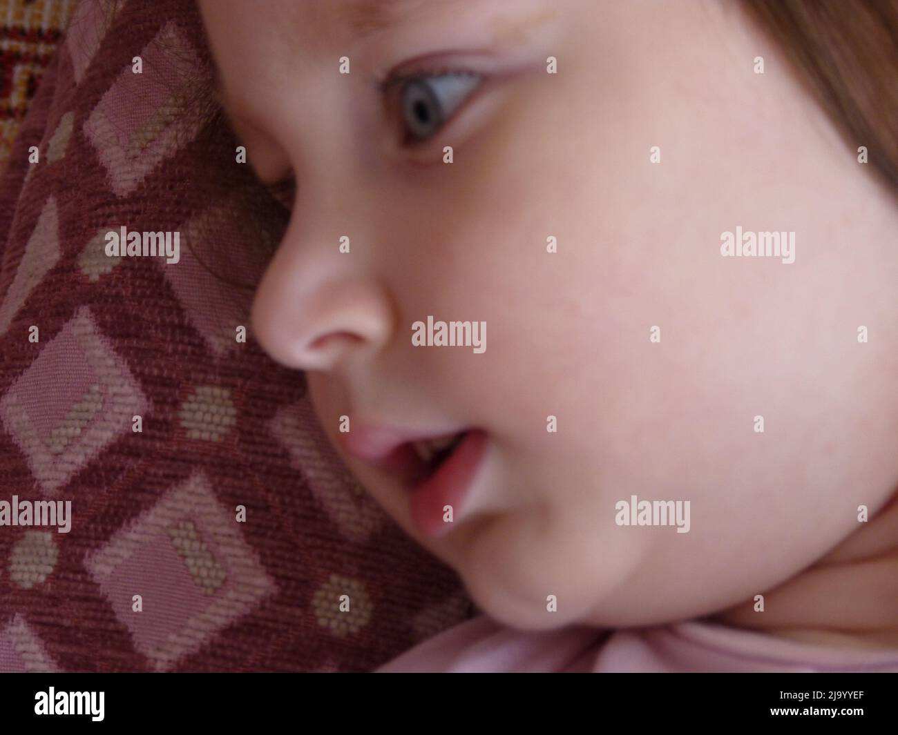 a blue-eyed girl makes strange facial movements Stock Photo - Alamy