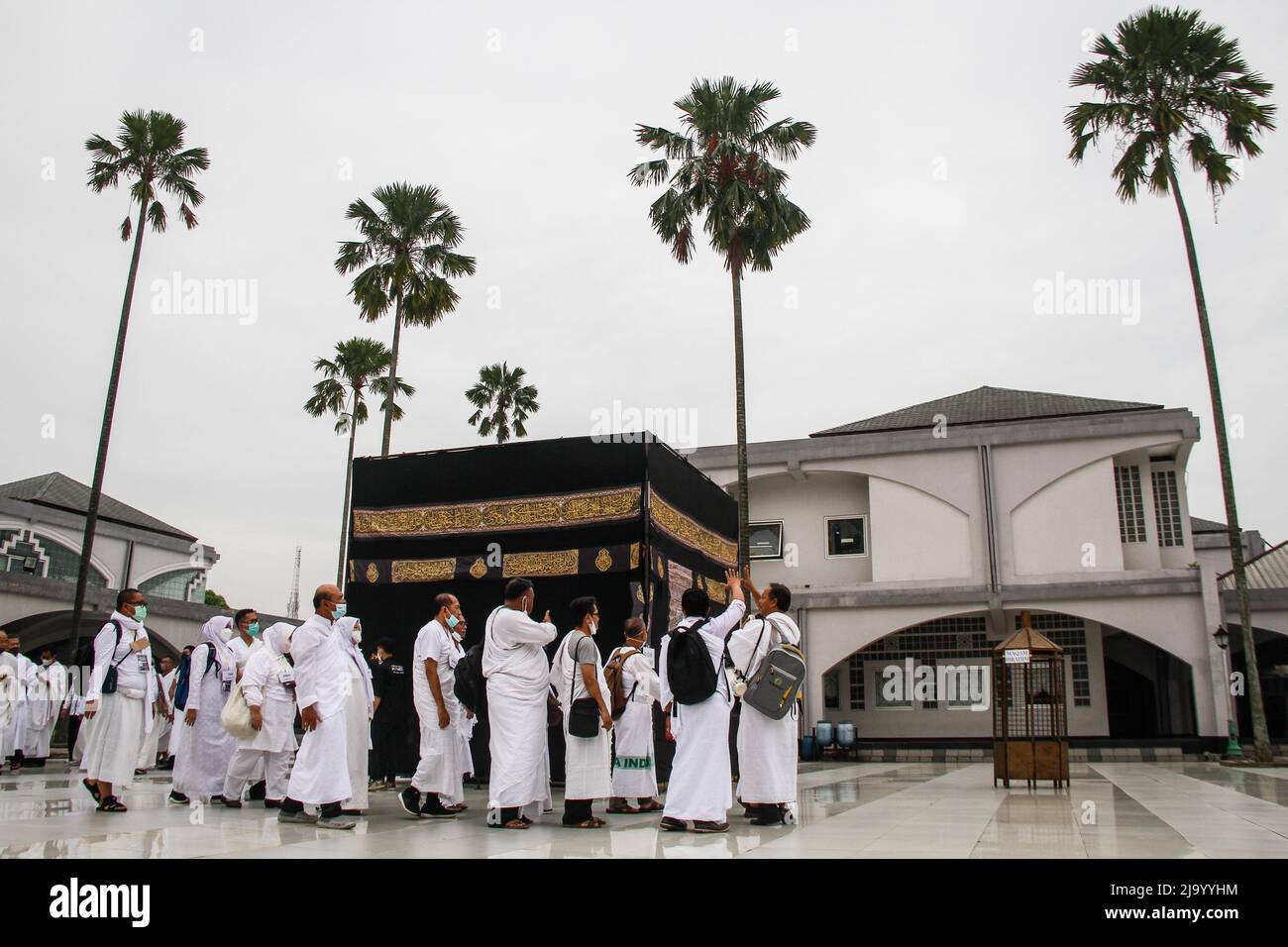 Indonesian Muslims simulate the circumambulation of a mock Kaaba as ...