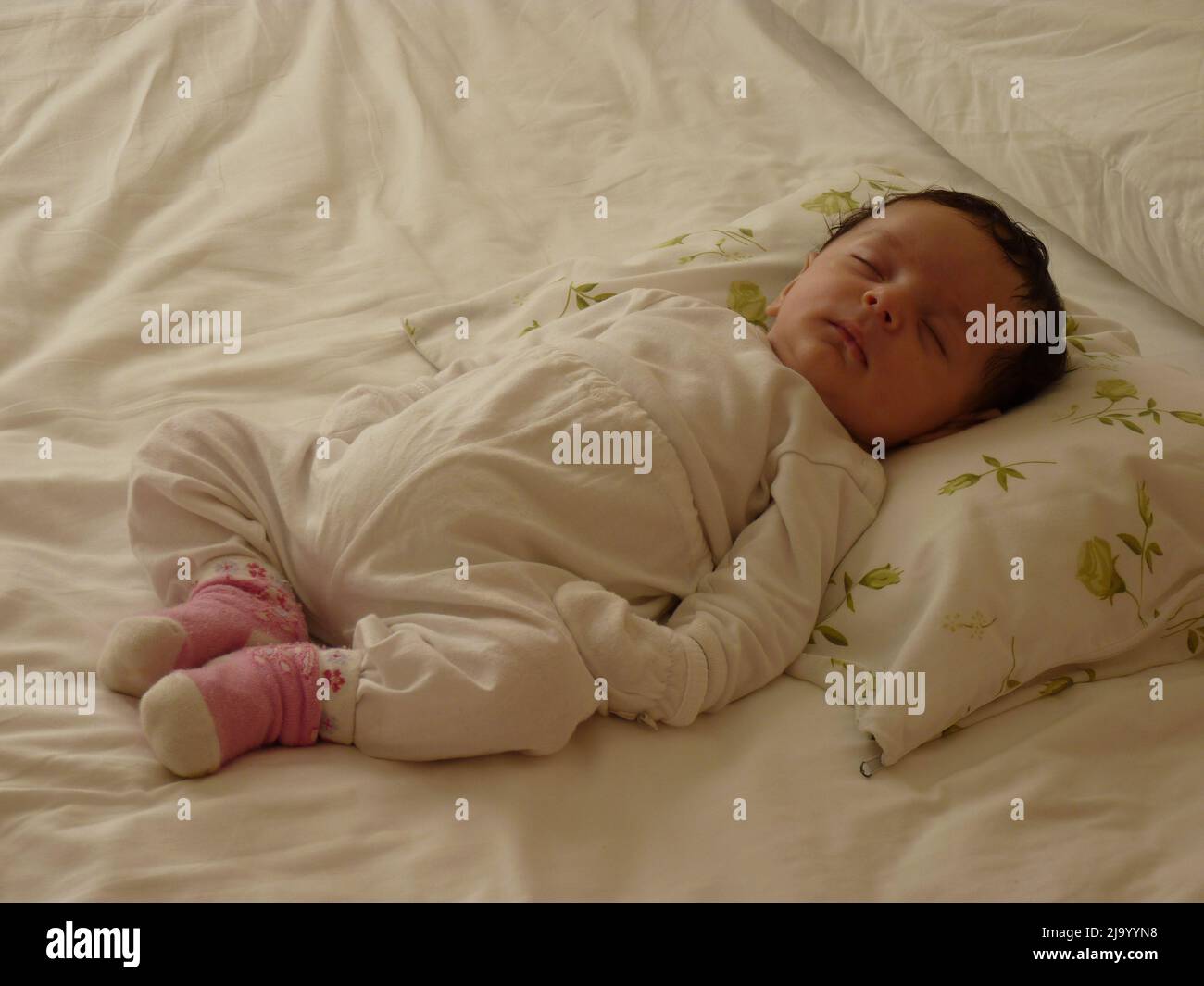 Newborn Baby Girl Sleeping In Crib