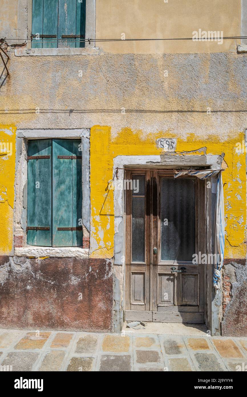 Weathered yellow painted house on Burano, Venice, Italy Stock Photo - Alamy