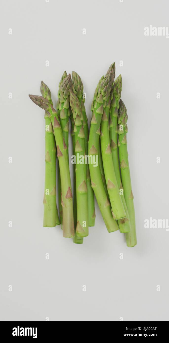 Vertical image of fresh stalks of asparagus on white background Stock ...