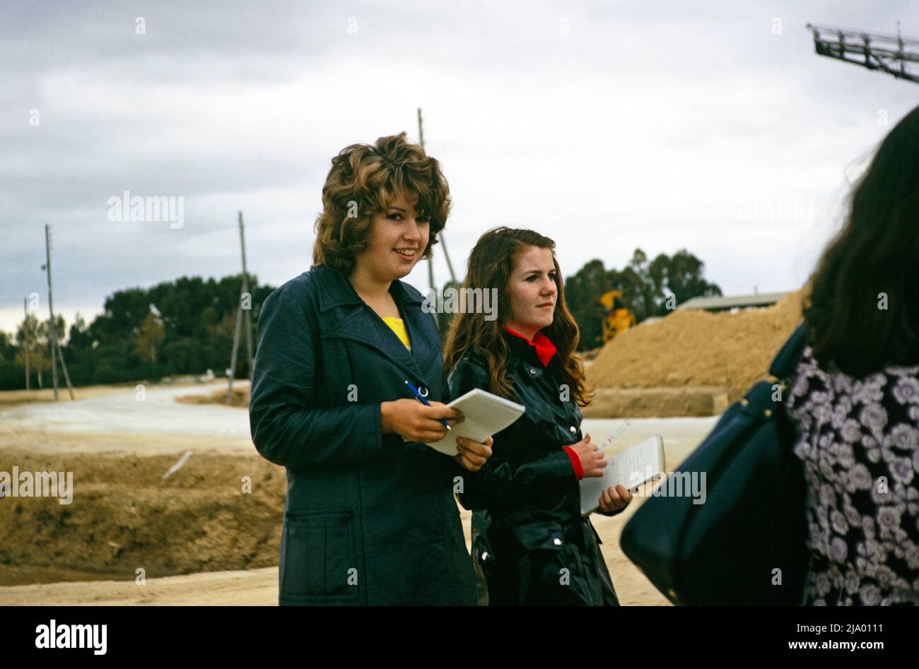 British female Sixth form geography students with notepads on fieldtrip ...