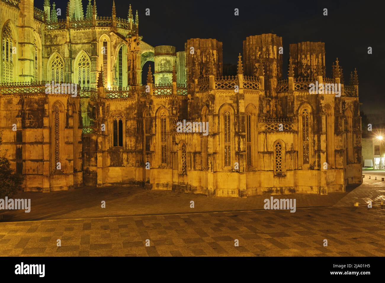 the western façade of the Batalha Monastery at night in Batalha ...