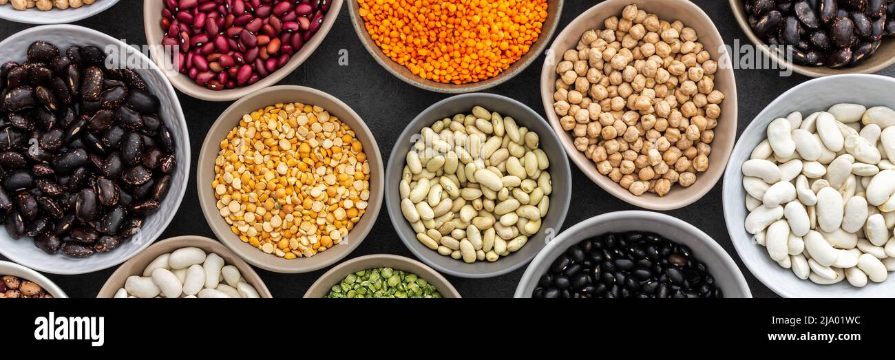 Banner of different types of legumes in bowls, green with yellow peas ...