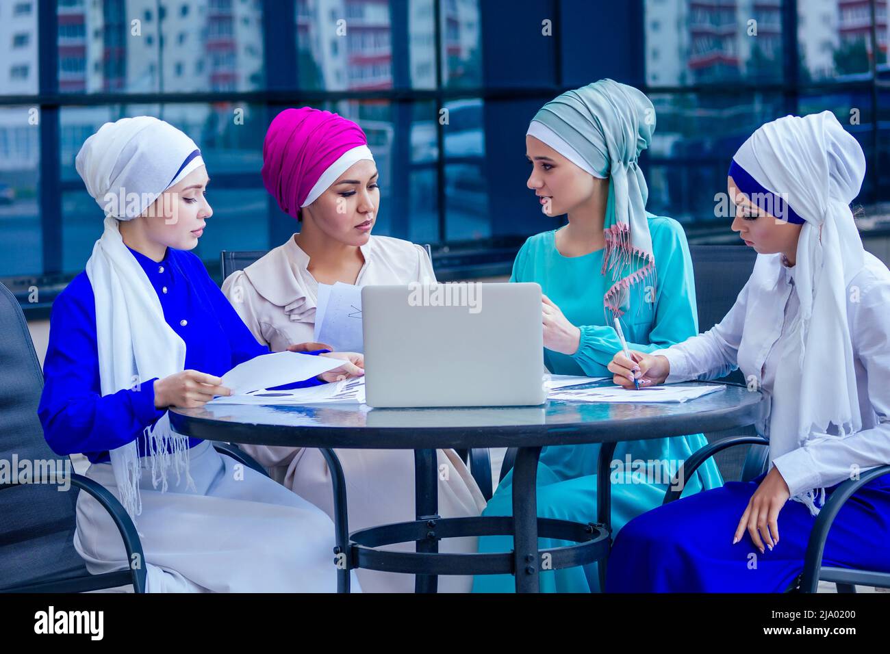 group of four caucasian Muslim office lady discussing with a ...