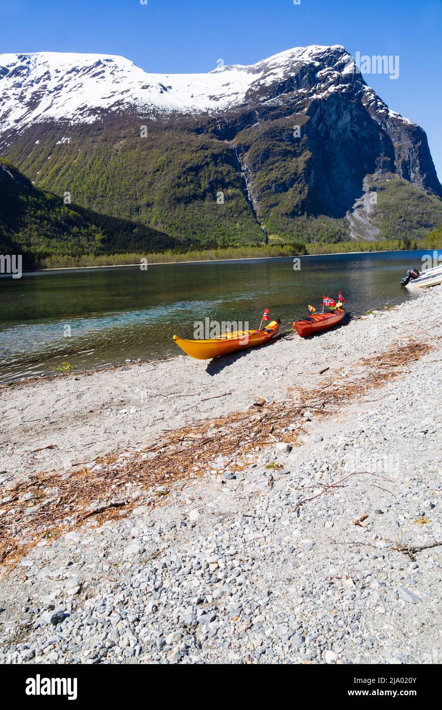 Two canoe kayaks on the shore with Norwegian flags. Lake Lovatnet from ...