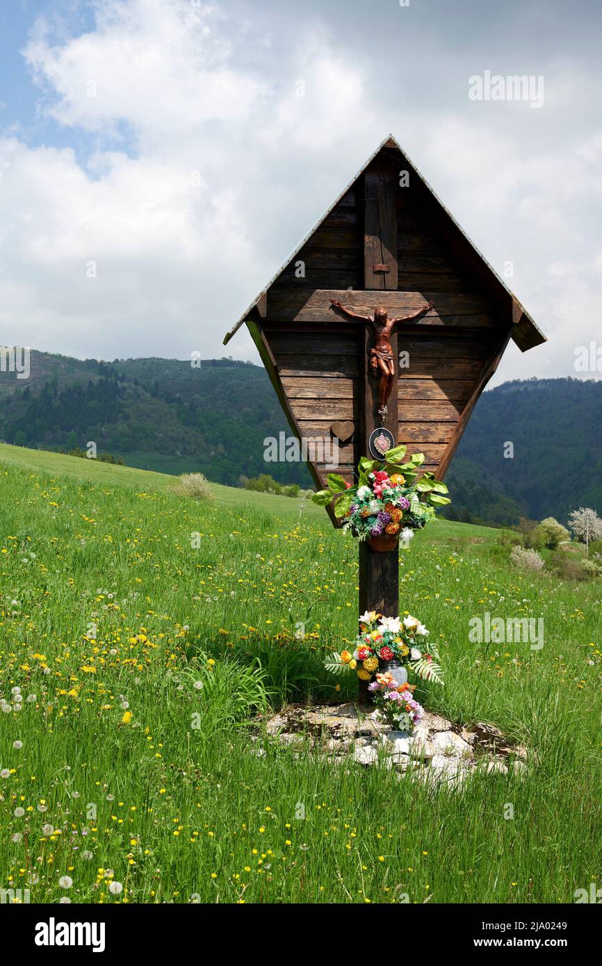 Monti Lessini (Vr), Italy, a holy shrine with a crucifix in a meadow ...
