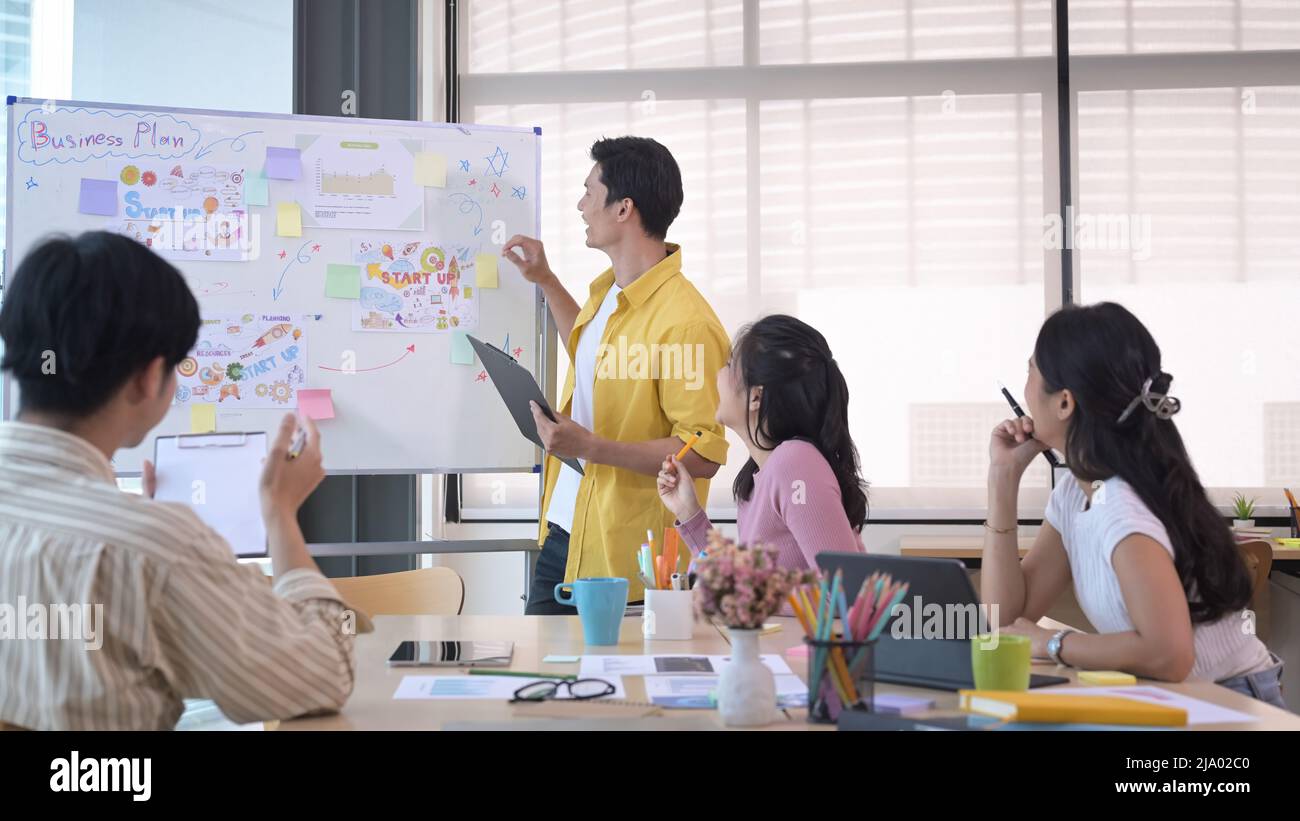 Asian male business team leader giving presentation start up business ...