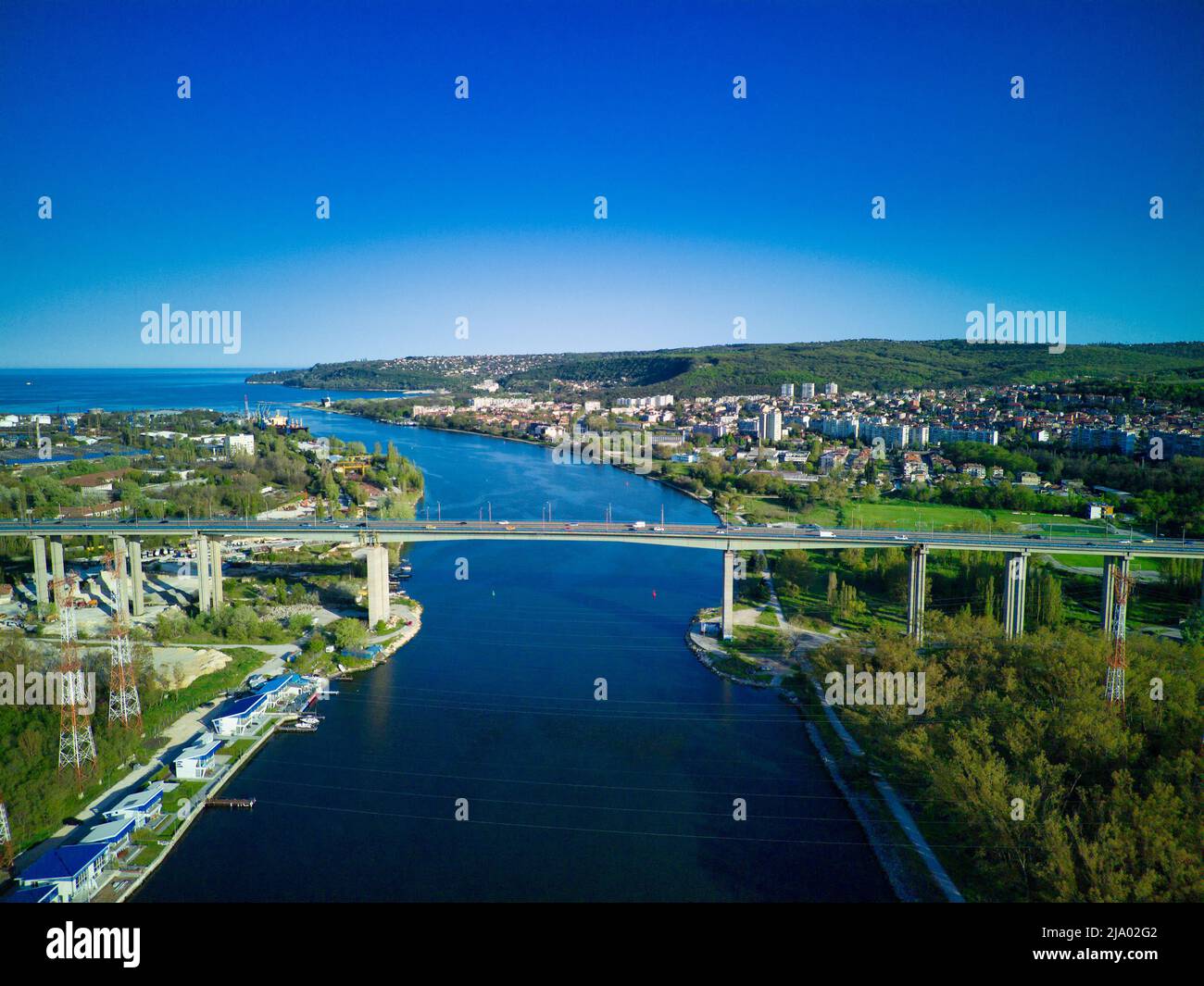 Bird's eye view of concrete sturdy road bridge between land of modern ...
