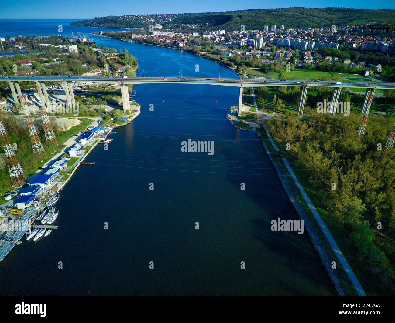 Bird's eye view of concrete sturdy road bridge between land of modern ...