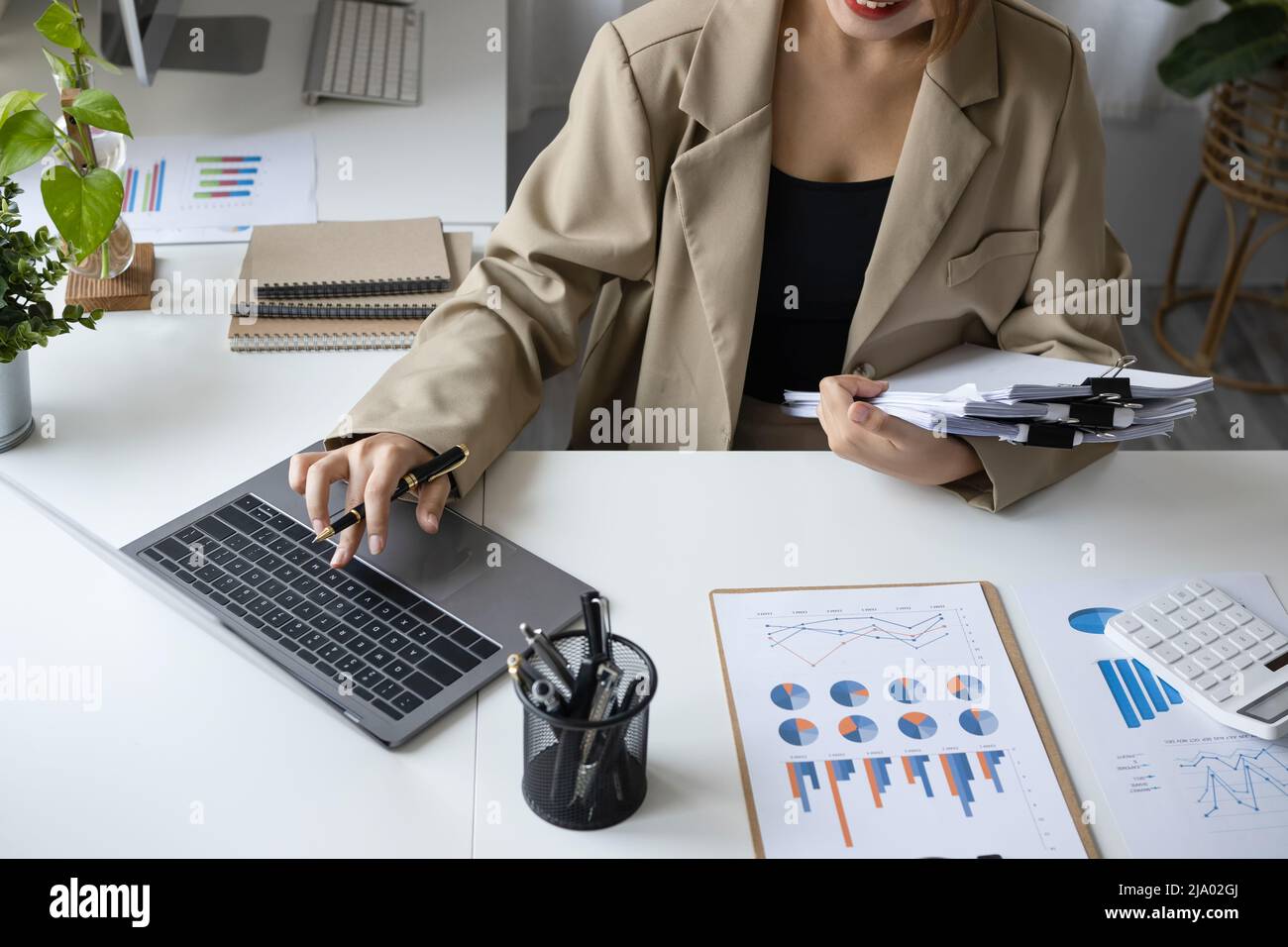Female finance manager using computer laptop on white office desk Stock ...