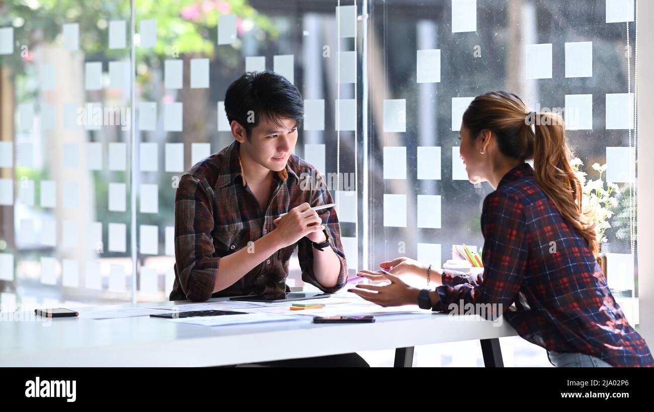 Focused creative team brainstorming and working together for mobile ...