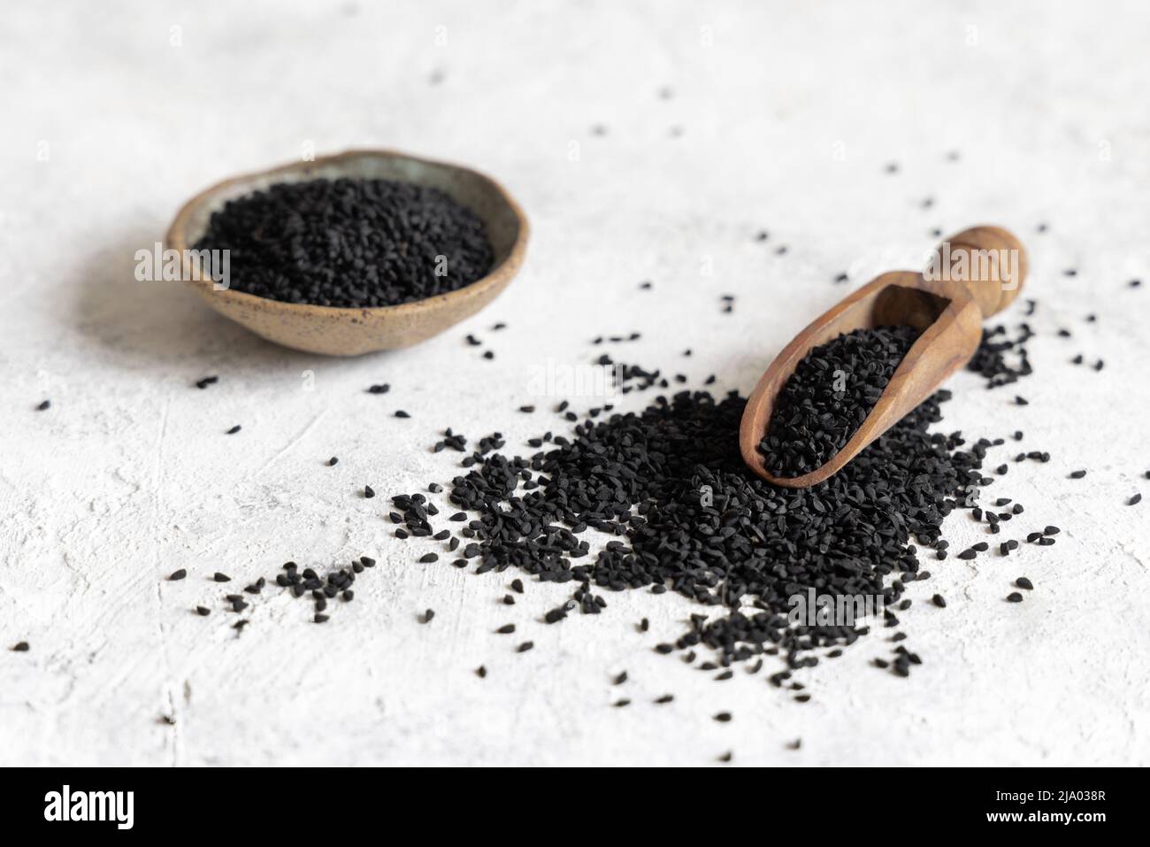 Scoop of Indian spice Black cumin (nigella sativa or kalonji) seeds on ...