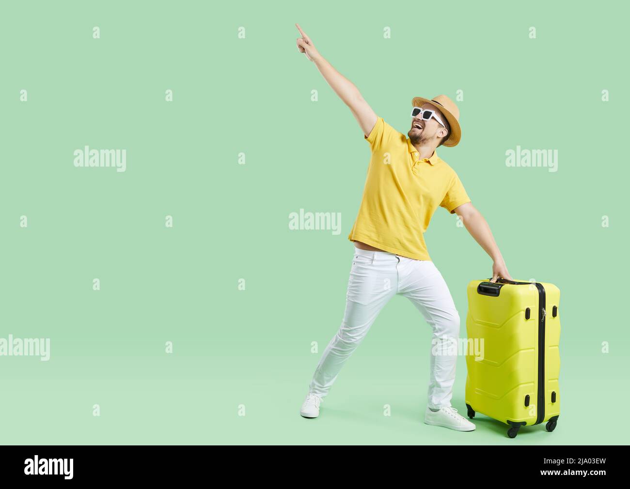 Funny guy going on holiday, having fun and showing something on green ...