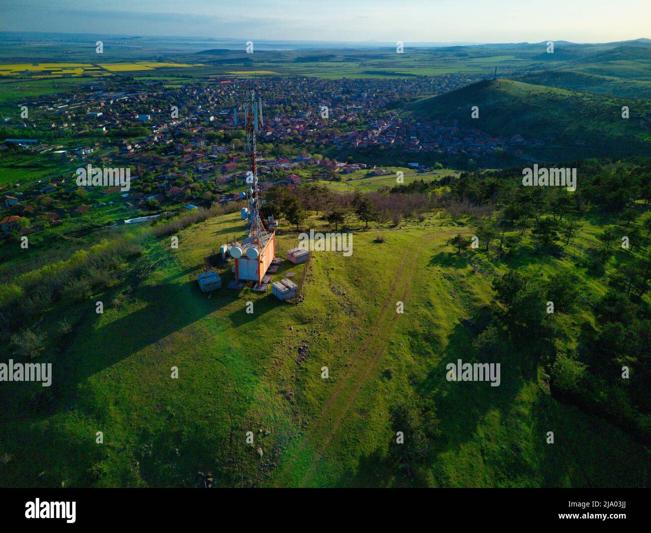 Bird's eye view of spring blooming green meadows and wooded hilly ...
