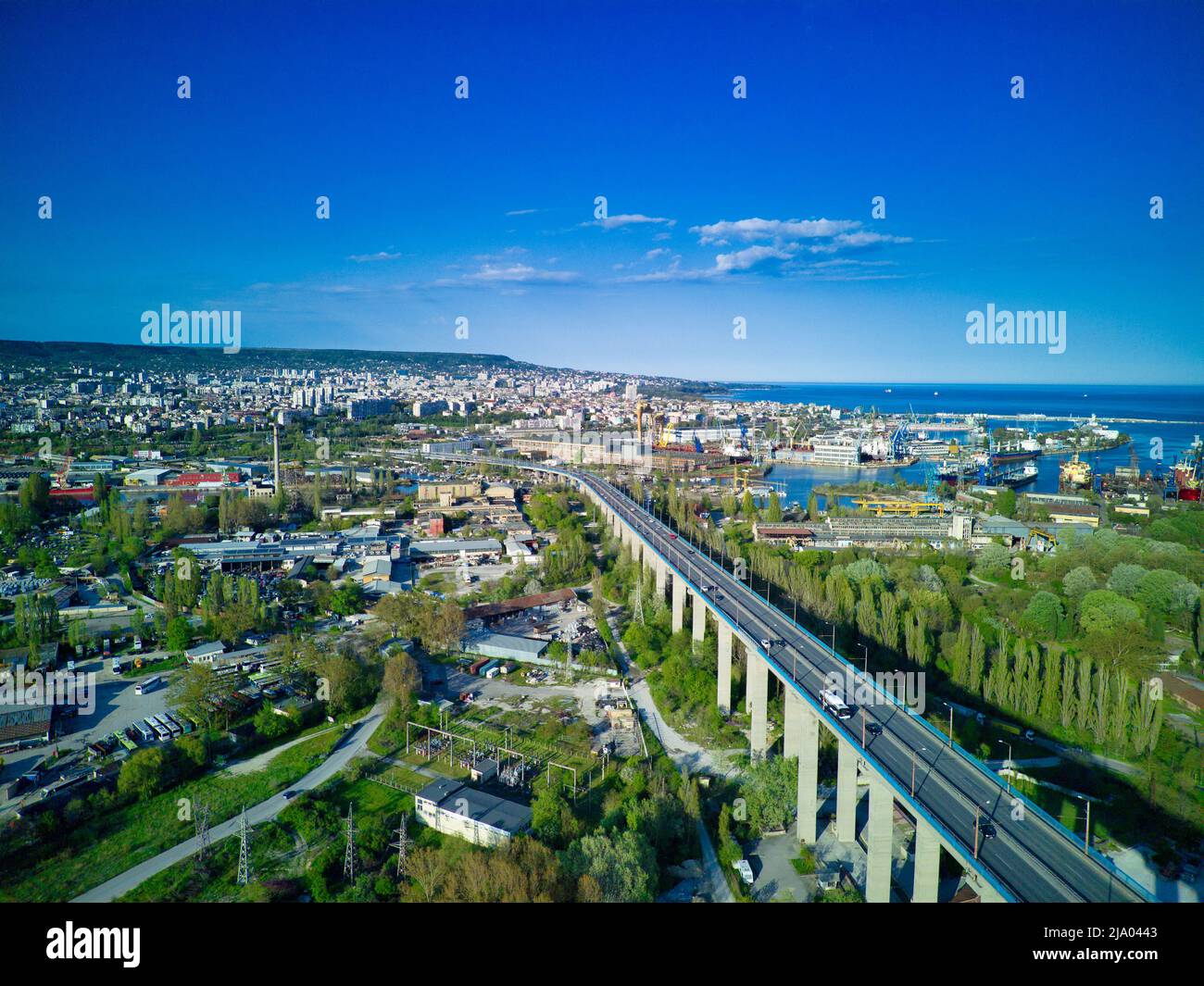 Bird's eye view of concrete sturdy road bridge between land of modern ...