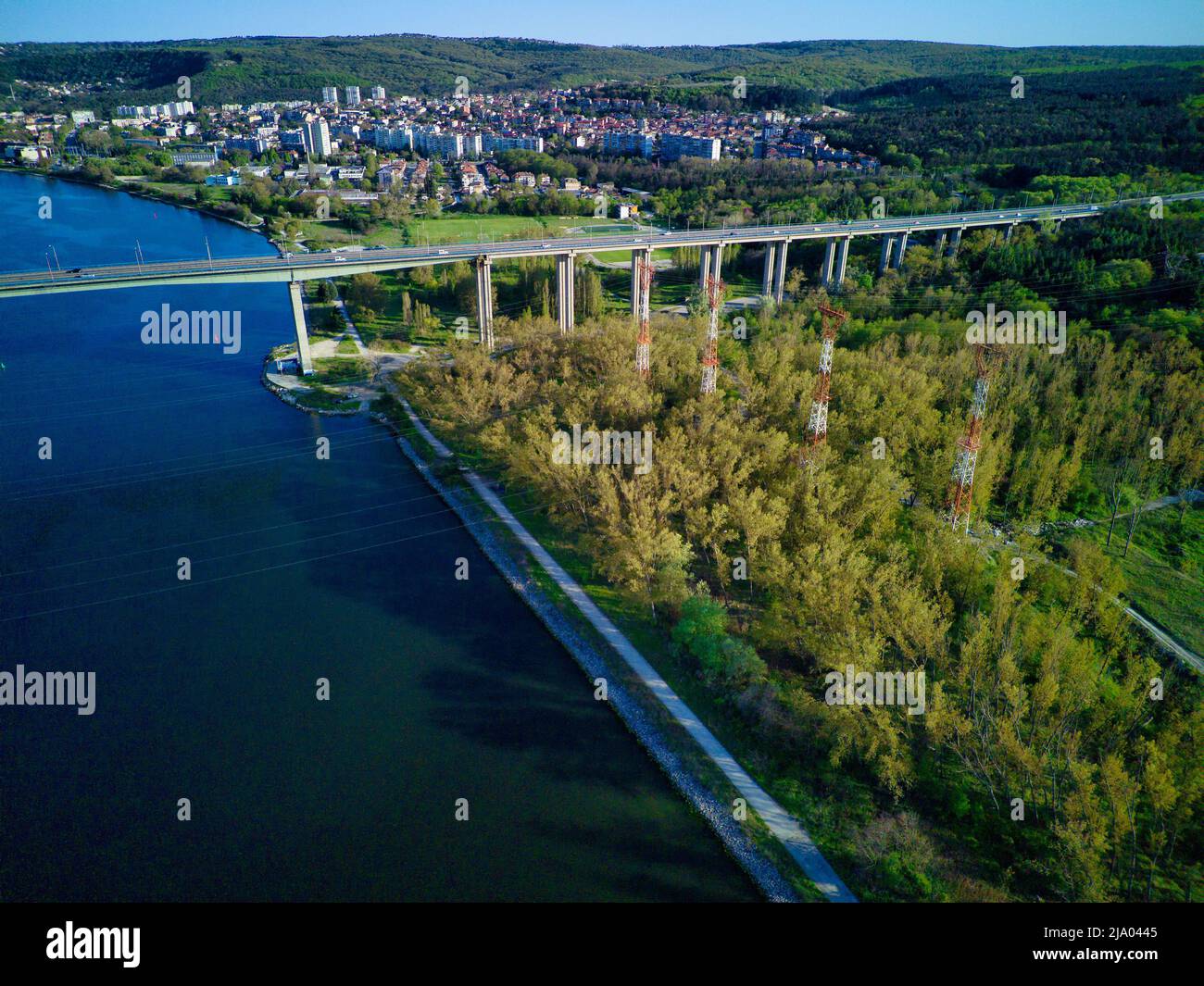Bird's eye view of concrete sturdy road bridge between land of modern ...