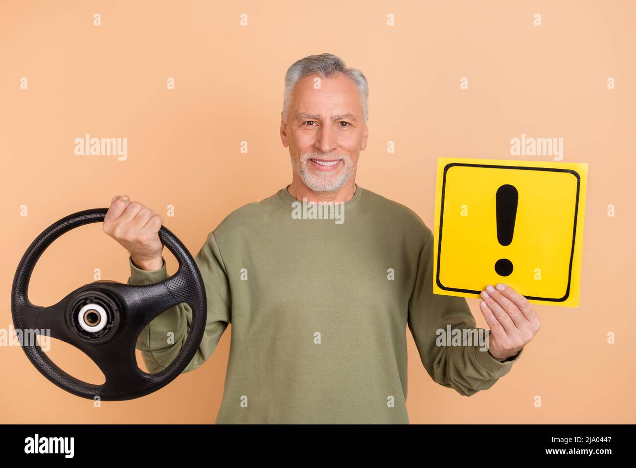 Photo of mature man hold steering-wheel sign beware road service ...