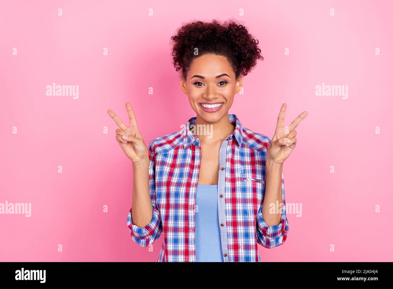 Photo of cool young curly hairdo lady show v-sign wear blue shirt ...