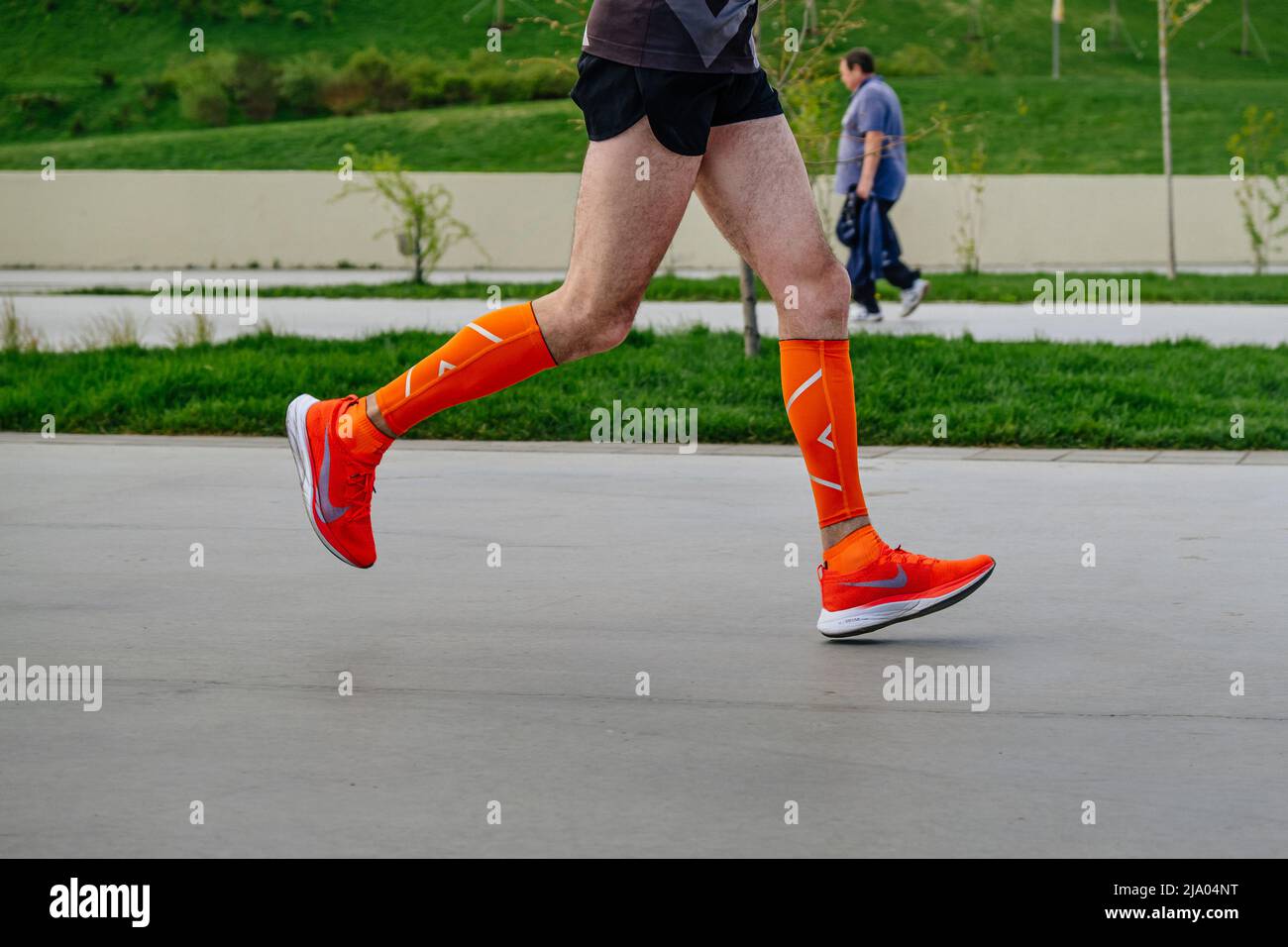 Kazan, Russia - May 17, 2022: legs runner in bright compression socks ...