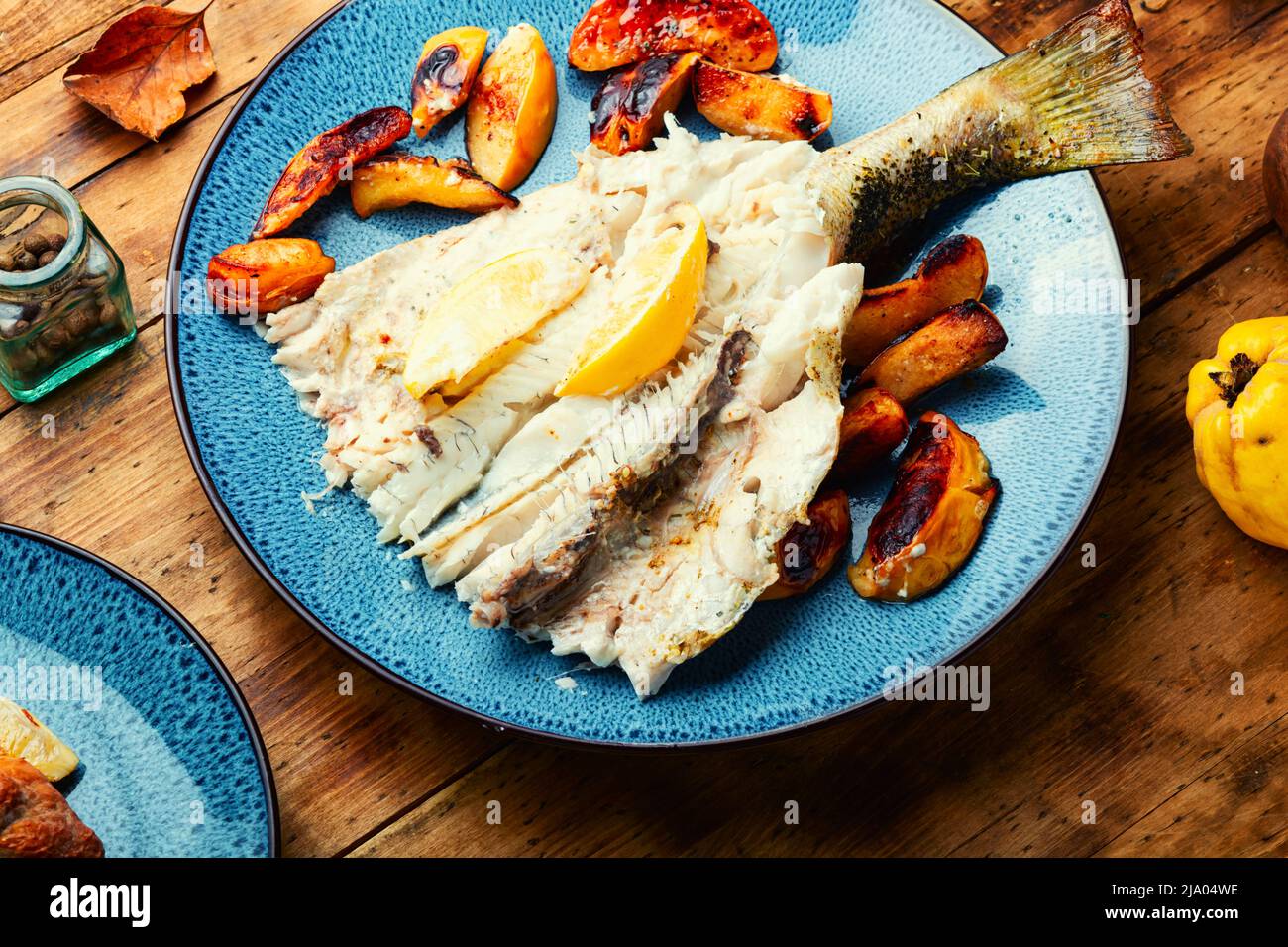 Fish pike perch roasted with quince and apple Stock Photo - Alamy