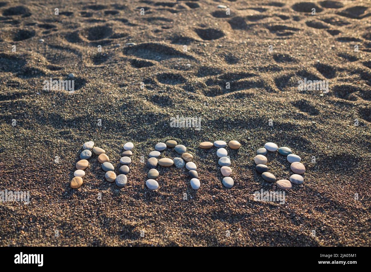 NATO word made with stones on sande beach. Protect Stock Photo - Alamy