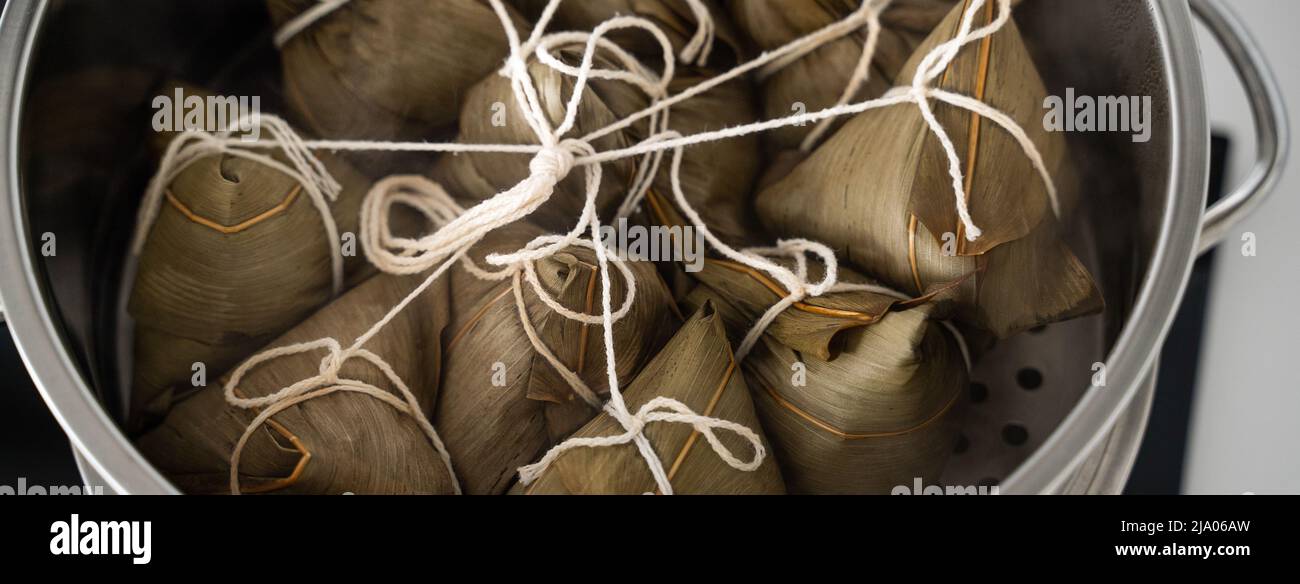 Cooking zongzi food - preparing and steaming Chinese rice dumpling at ...