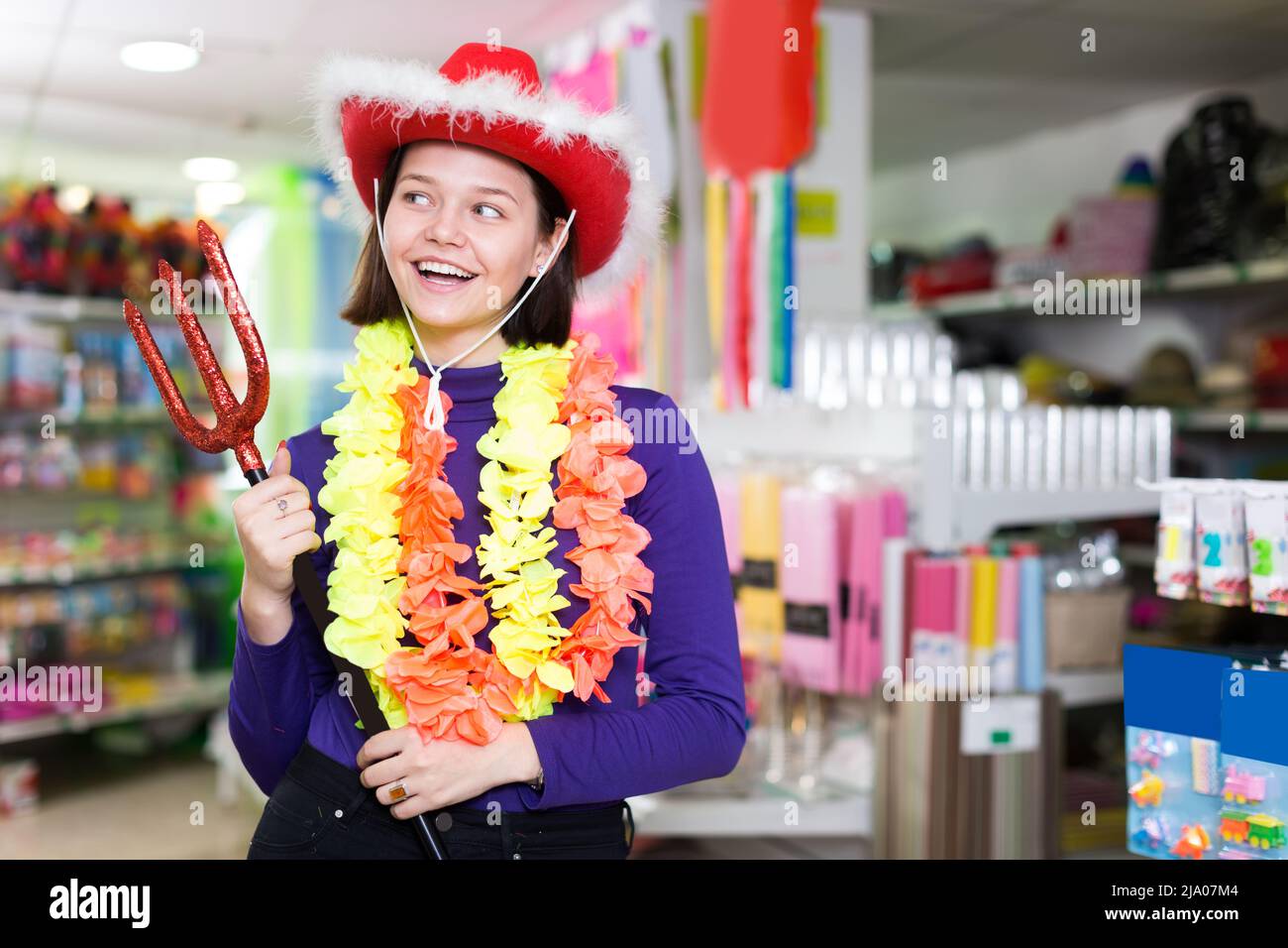 girl looking for things in shop of festival outfits Stock Photo - Alamy