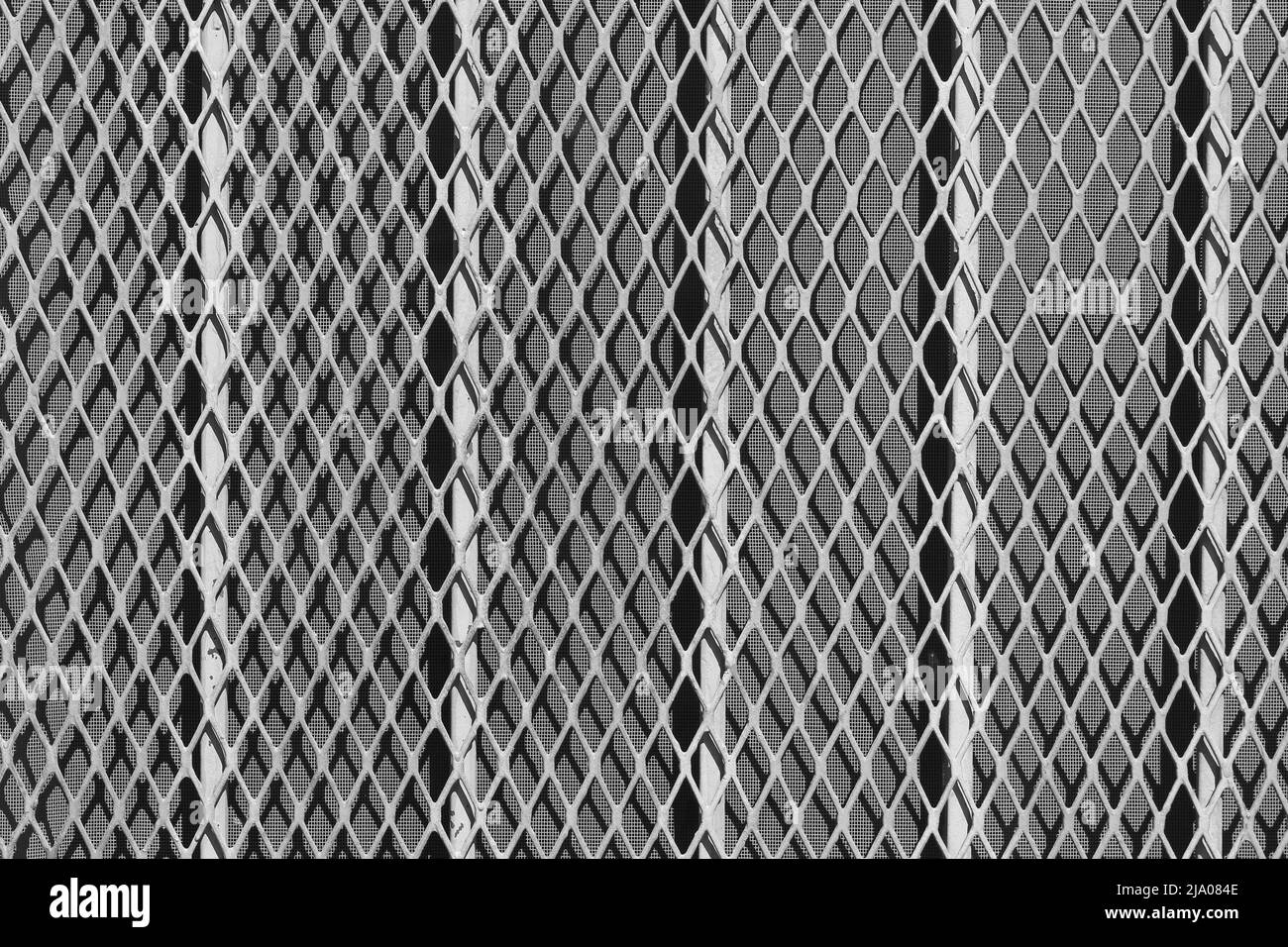 Heavy duty security metal grill protecting a warehouse window in black ...