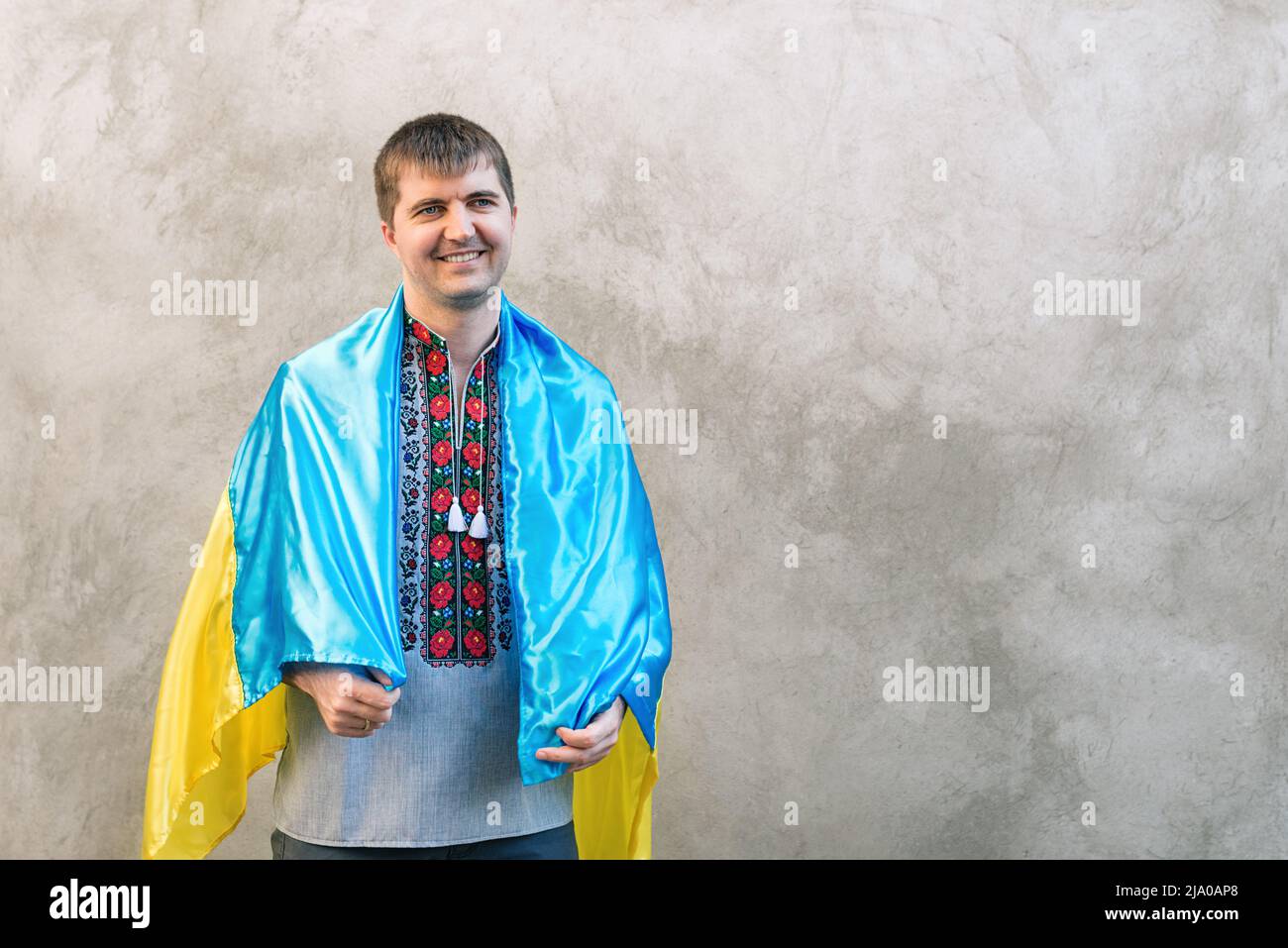 Young smiling Ukrainian dresses the blue and yellow State Flag of ...