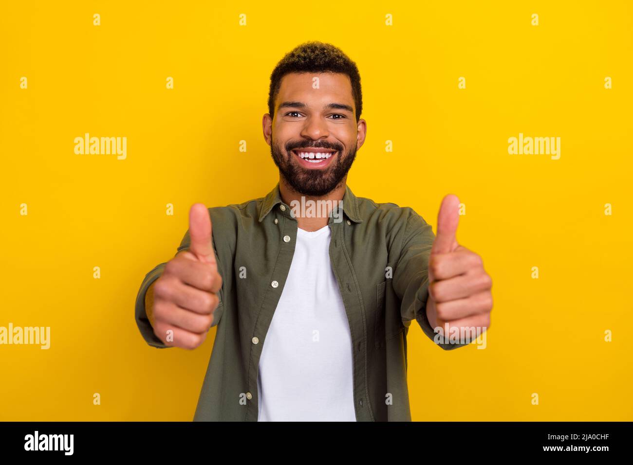 Photo of funky pretty guy dressed green shirt showing you two thumbs up ...