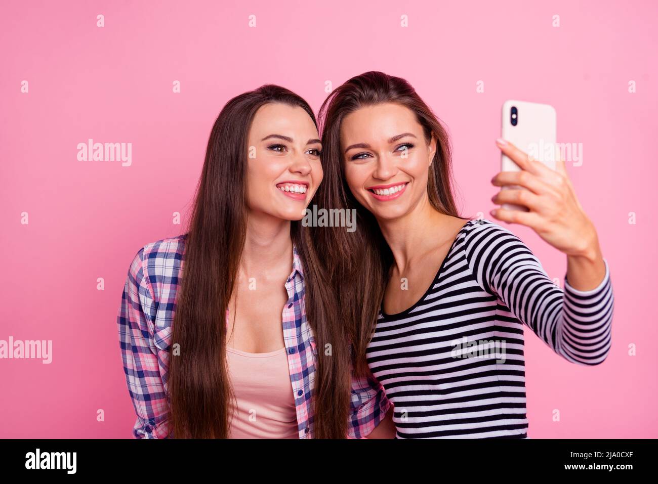 Portrait of two charming nice girls make selfie recording video ...
