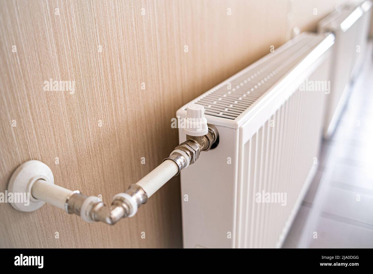 White radiator regulator. Detail of the radiator on the background of ...