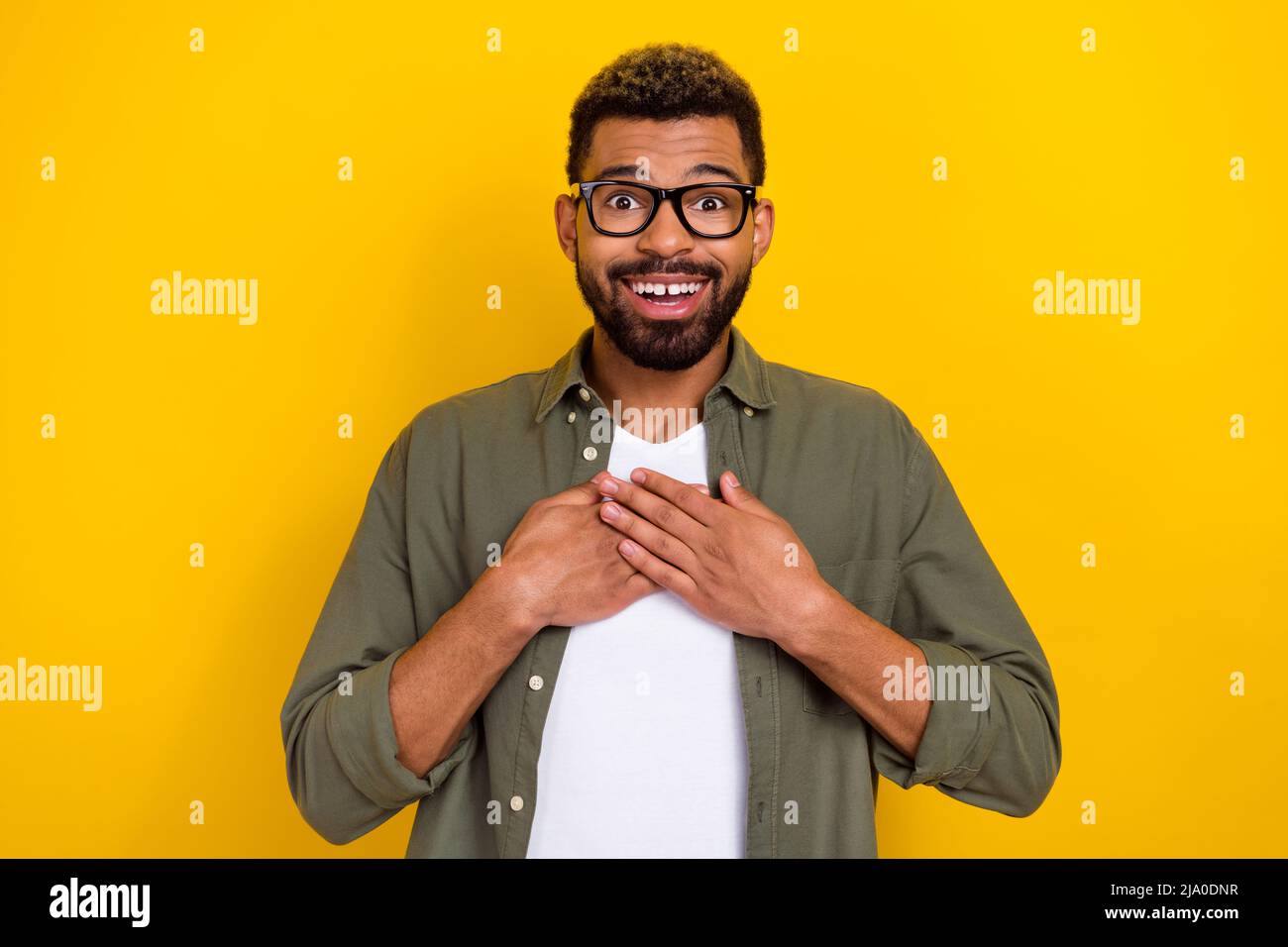 Photo of dreamy charming guy dressed green shirt eyewear arms chest ...