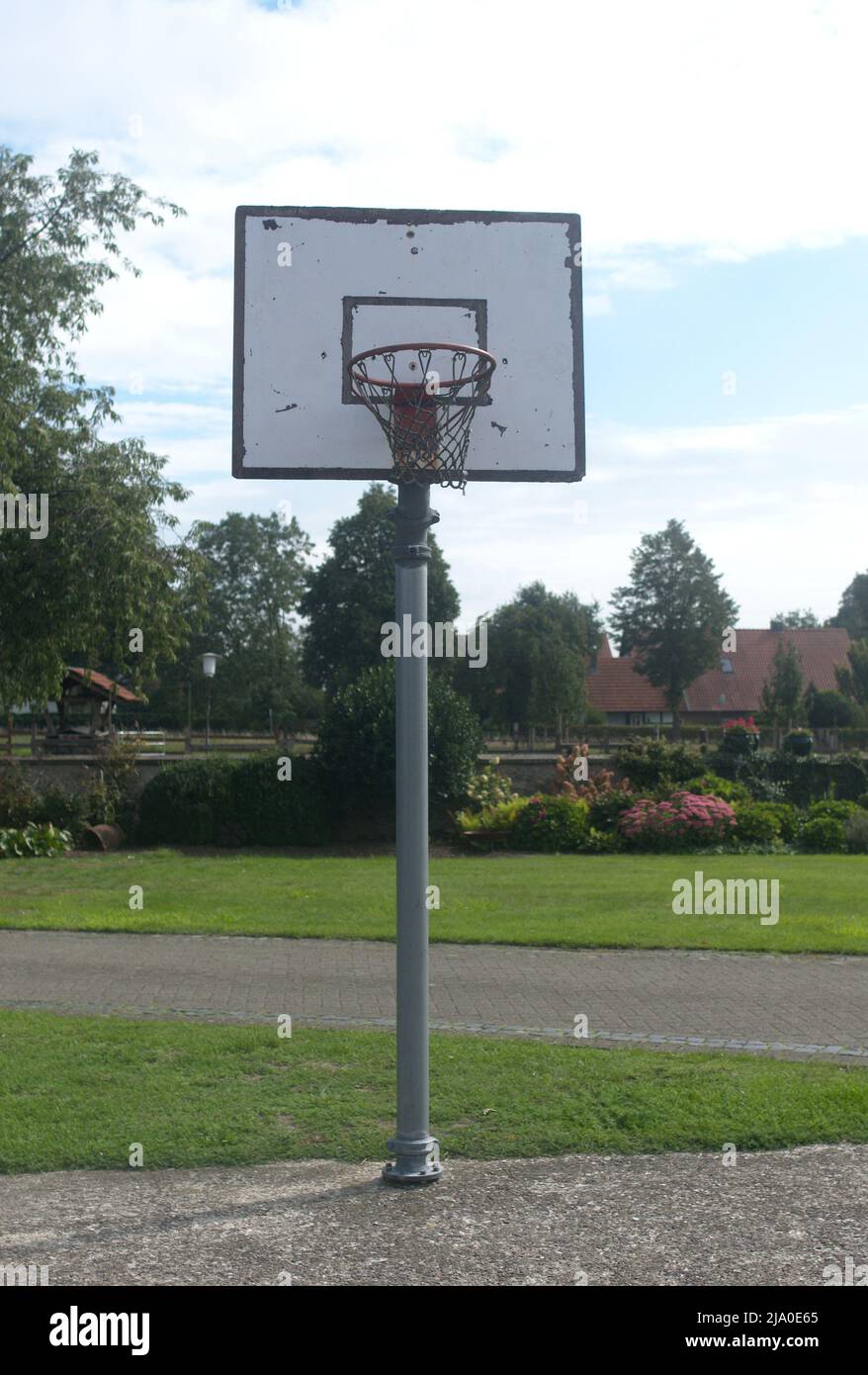 Basketball hoop on long pole mast farm in the background green meadow ...