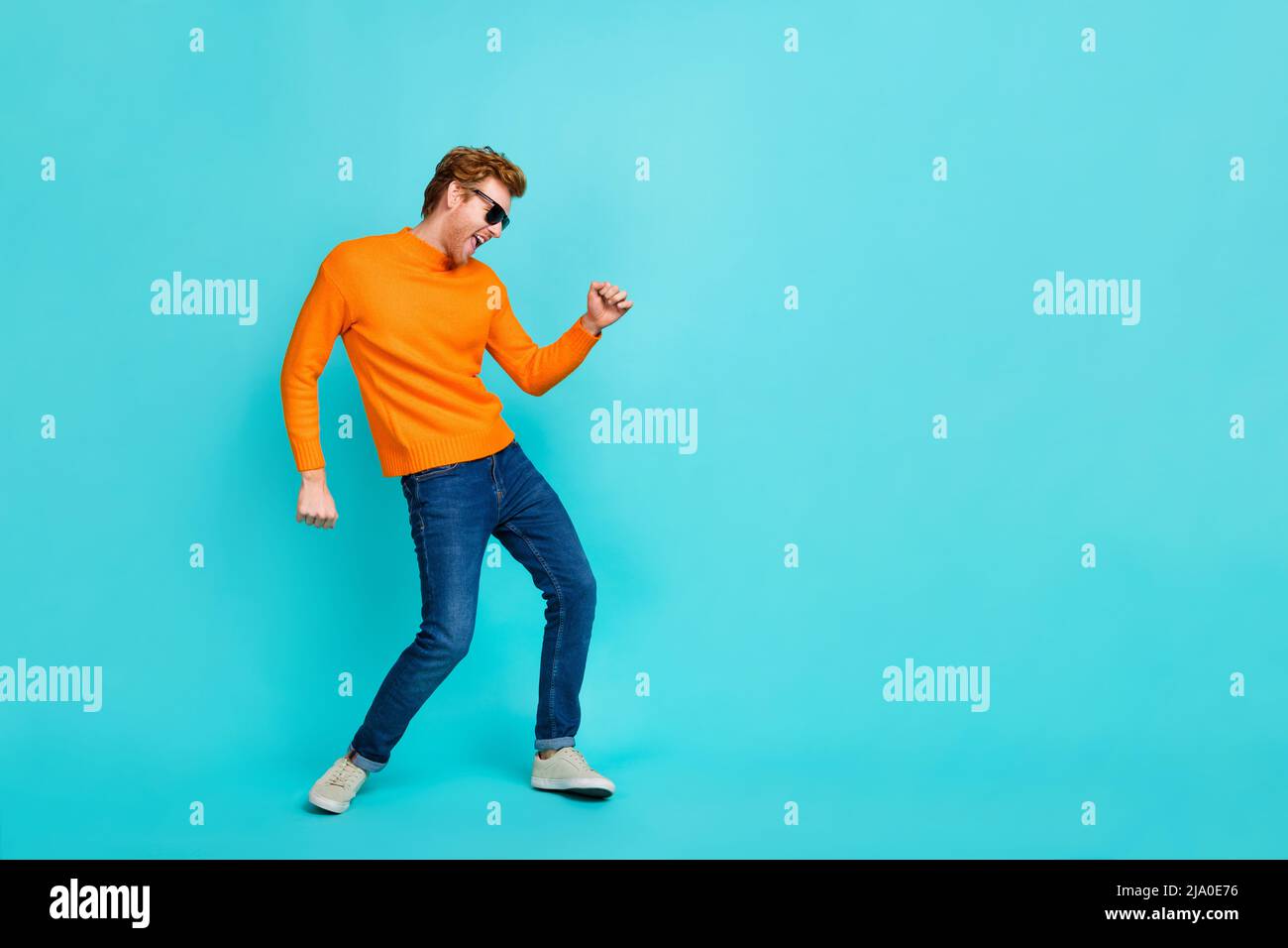 Full length photo of pretty funky guy dressed orange sweater dark ...