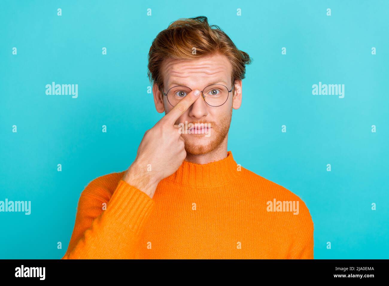 Photo of positive smart young man wear orange pullover arm adjusting ...