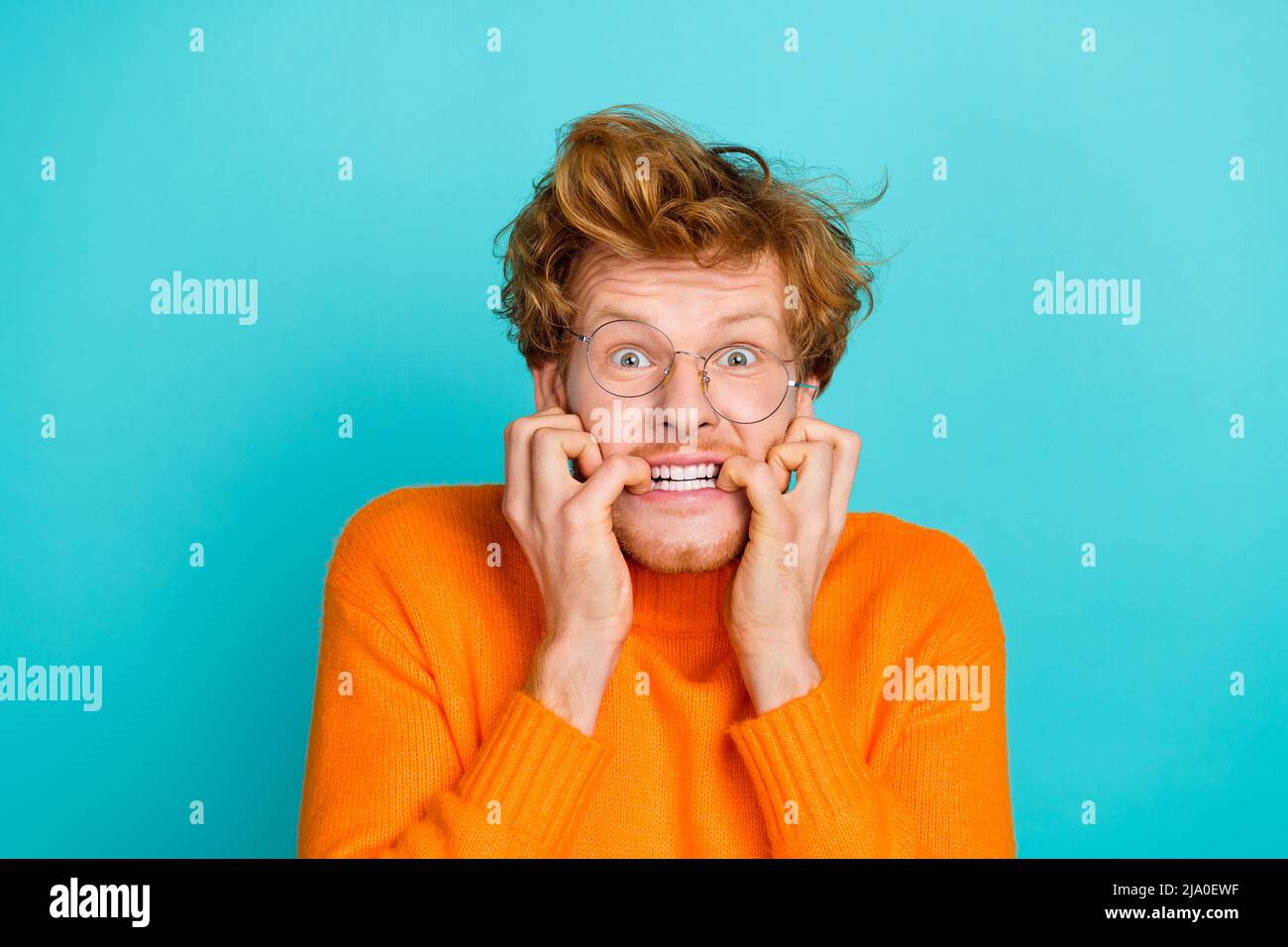 Photo of scared afraid guy dressed orange sweater eyewear biting ...