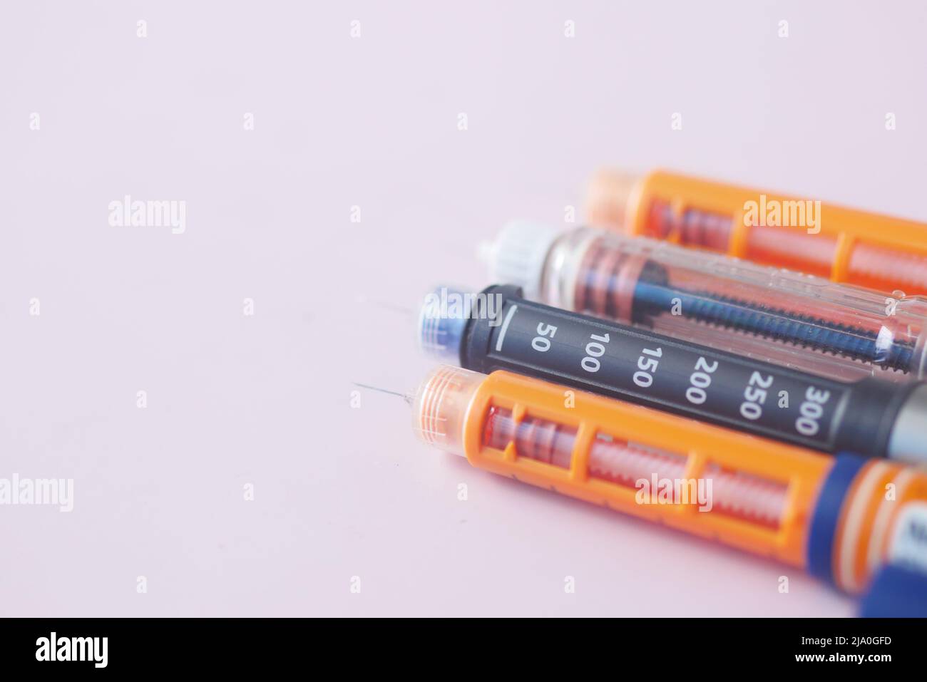 many Insulin pens on light pink background Stock Photo - Alamy