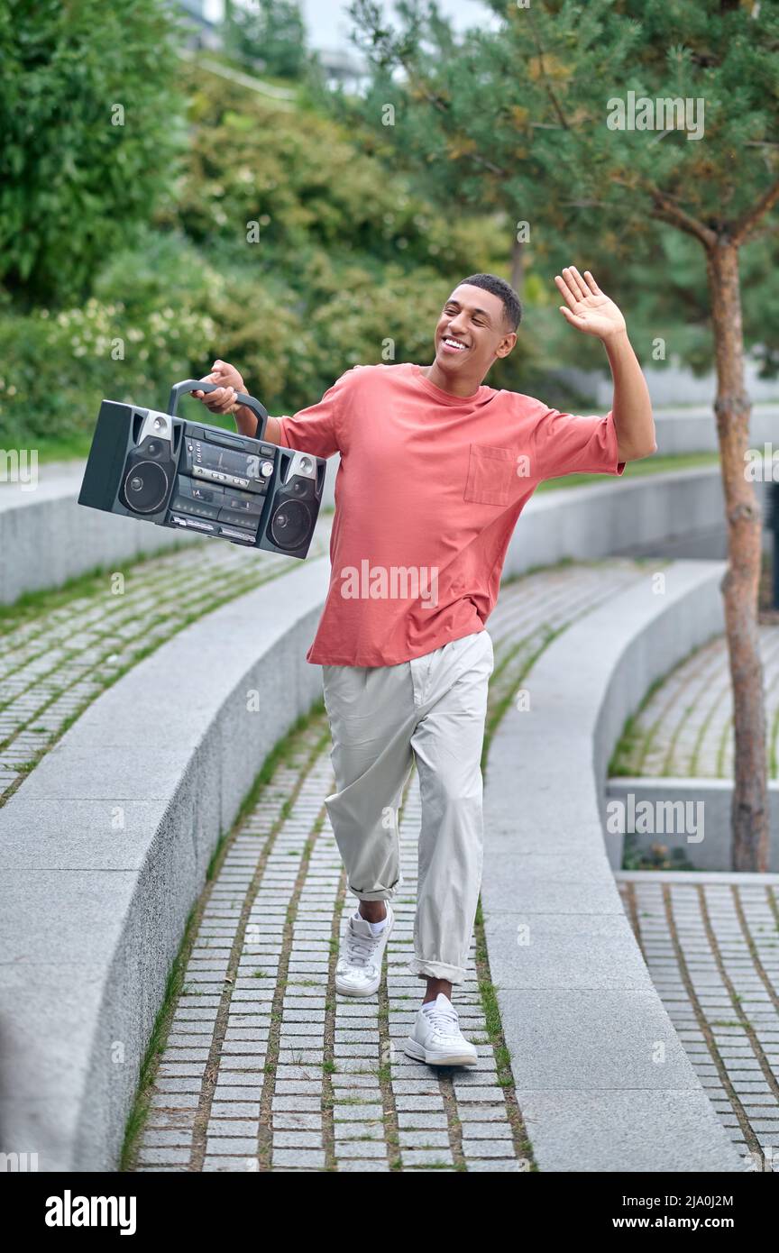 Guy with record-player raising his hand in greeting Stock Photo - Alamy