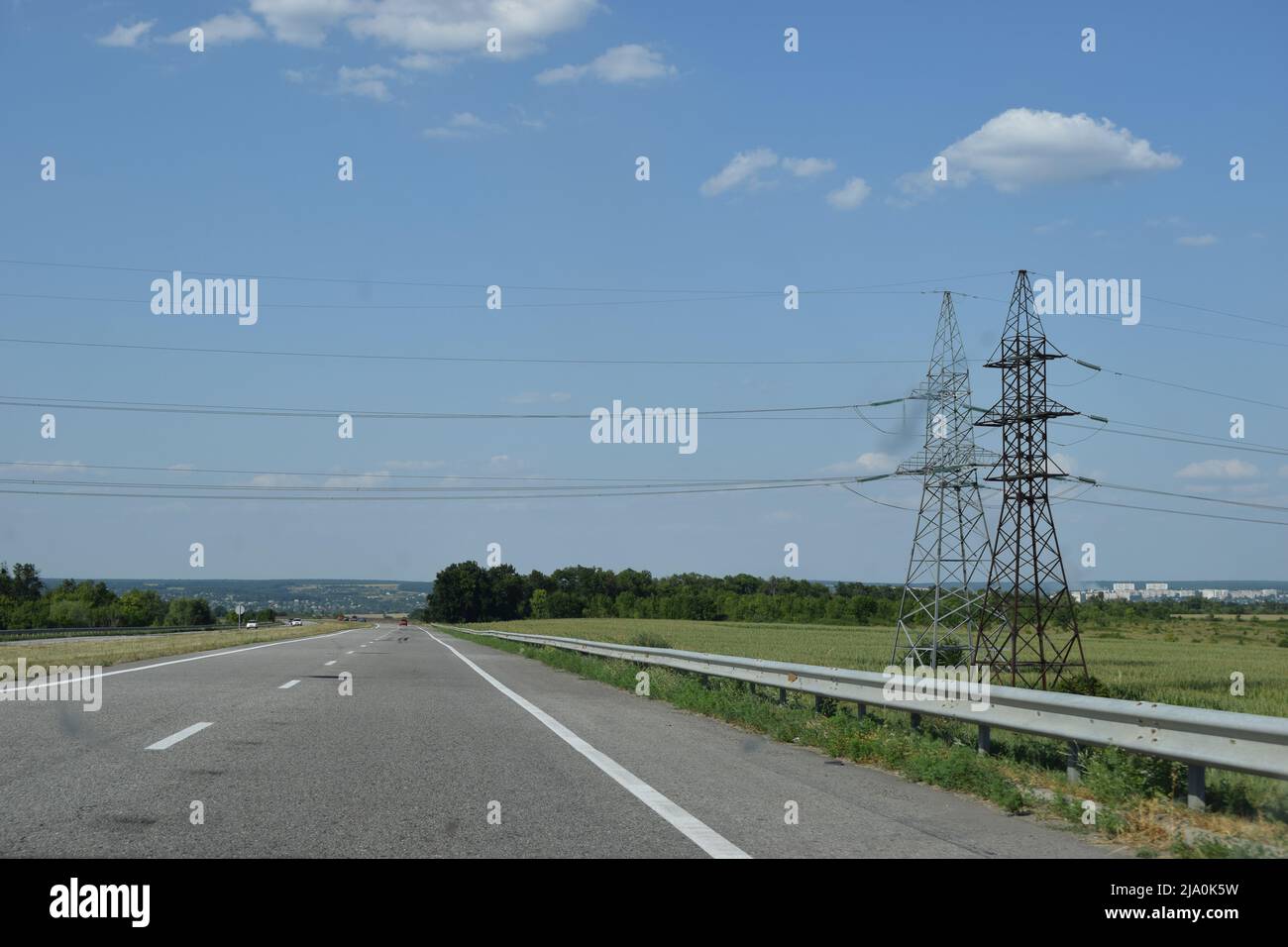 High voltage transmission towers, where many wires, have a clear sky ...